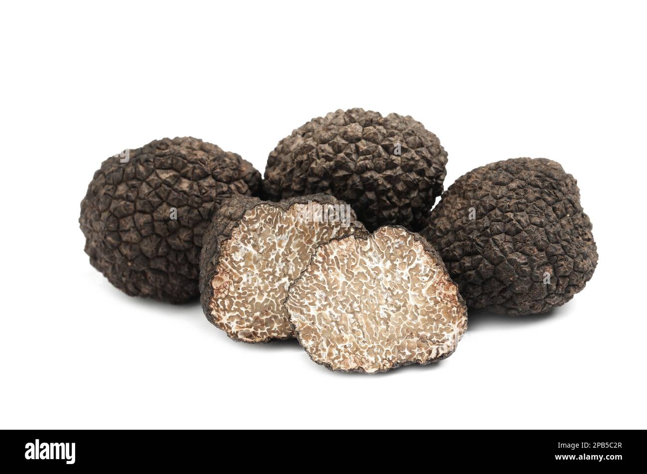 Cut and whole black truffles isolated on white Stock Photo - Alamy