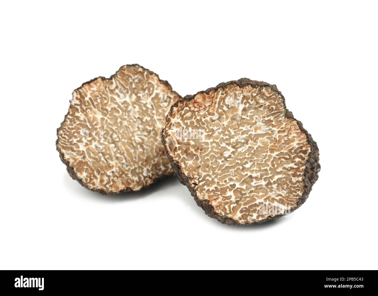 Cut fresh black truffle isolated on white Stock Photo - Alamy