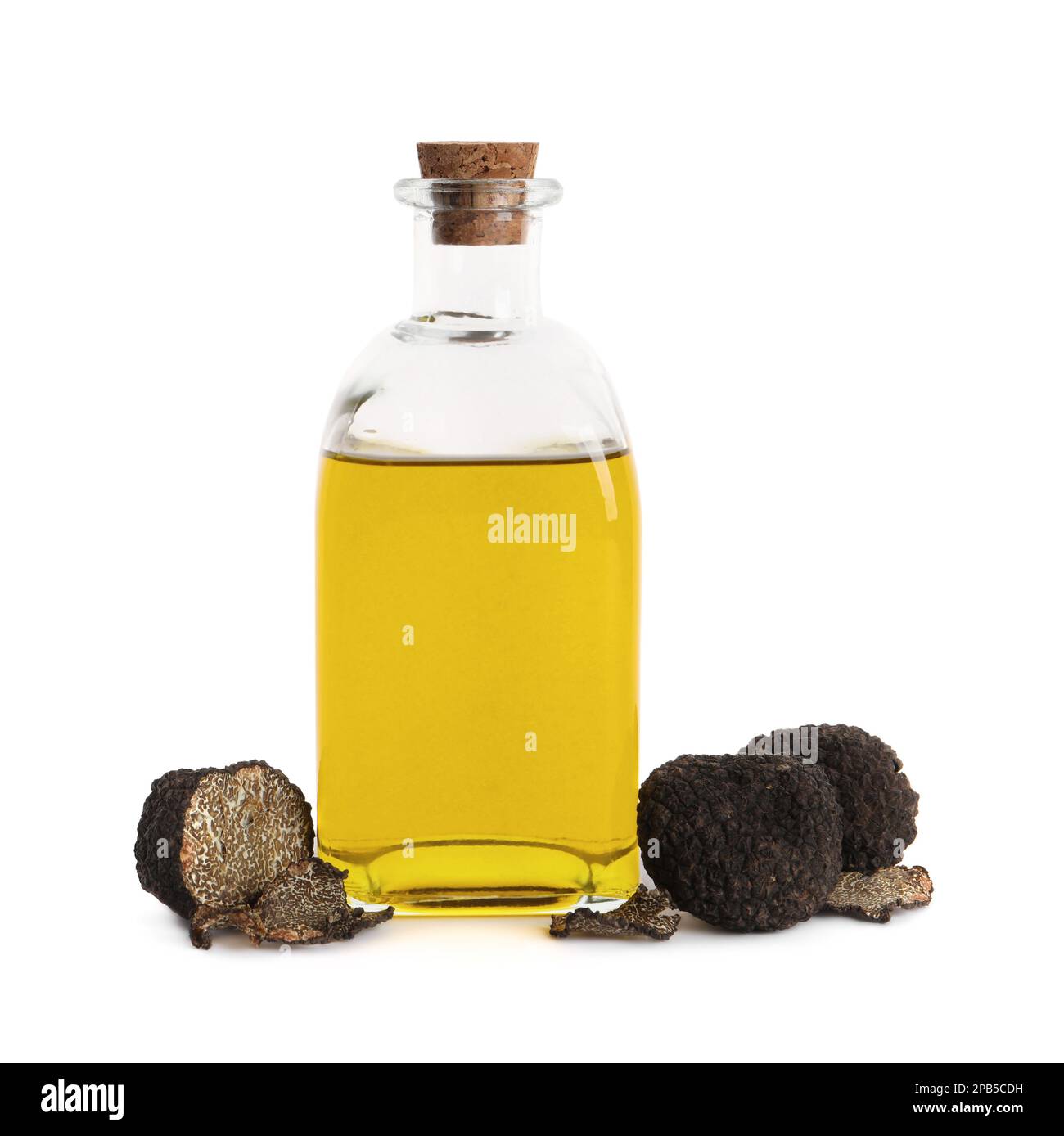 Glass bottle of oil and fresh truffles on white background Stock Photo ...
