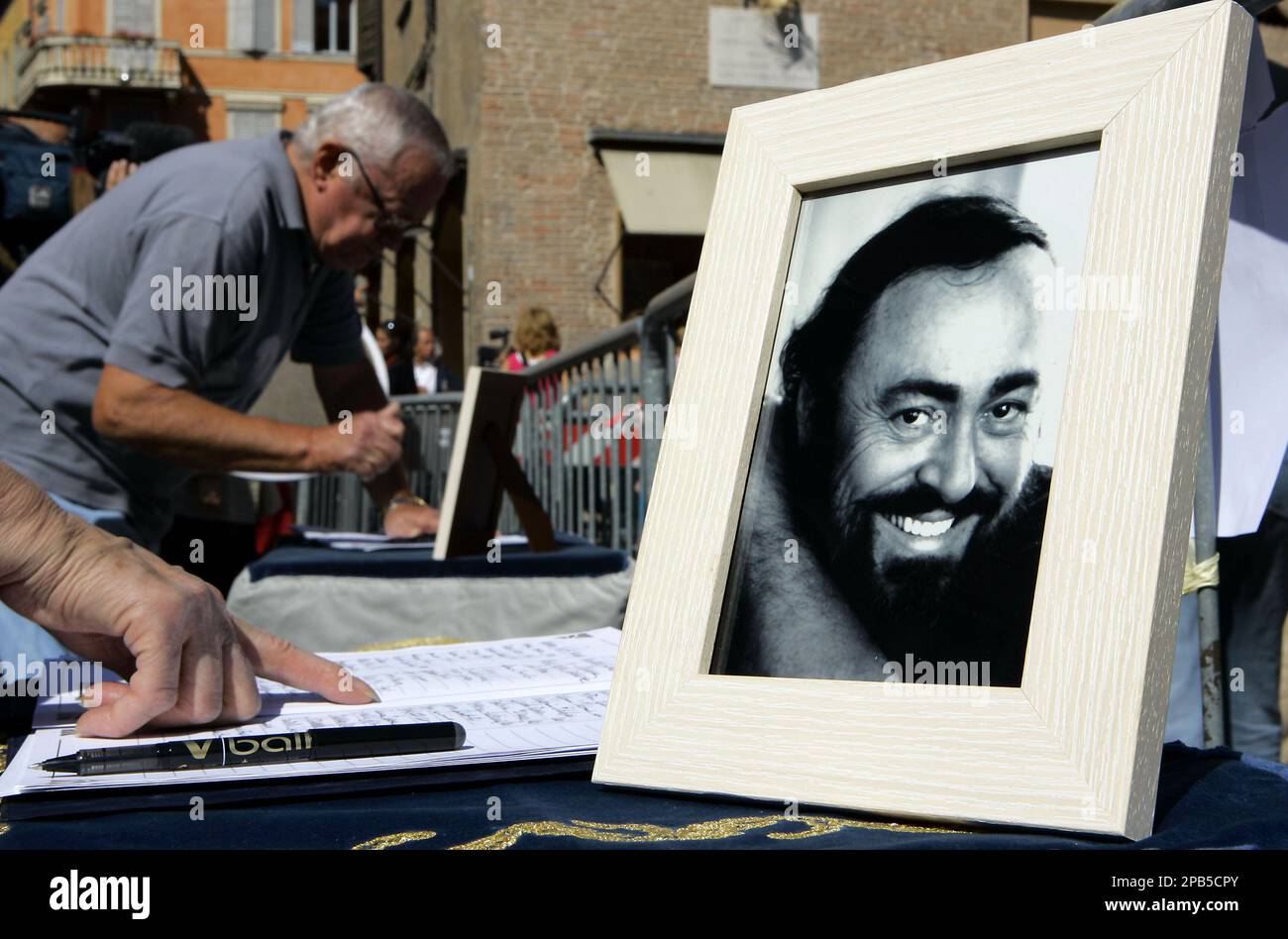 People sign a visitors book outside Modena's cathedral where the body ...