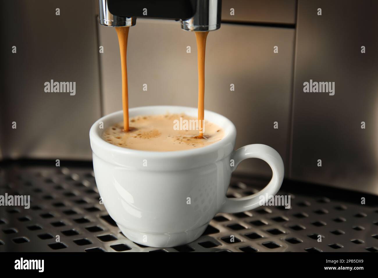 Espresso machine pouring coffee into cup, closeup Stock Photo - Alamy