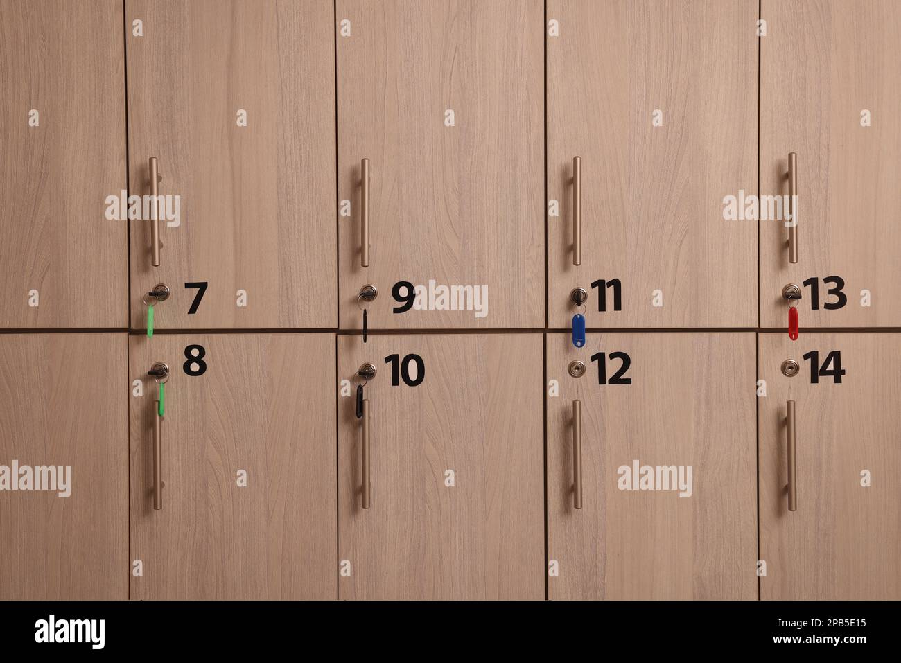 Many wooden lockers with keys and numbers on doors Stock Photo - Alamy