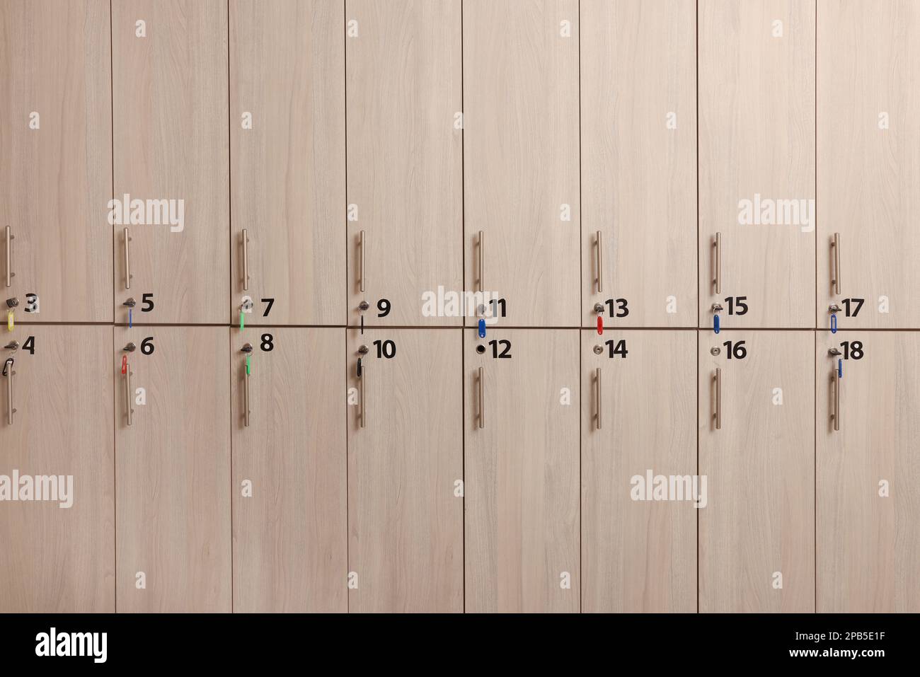 Many wooden lockers with keys and numbers on doors Stock Photo - Alamy
