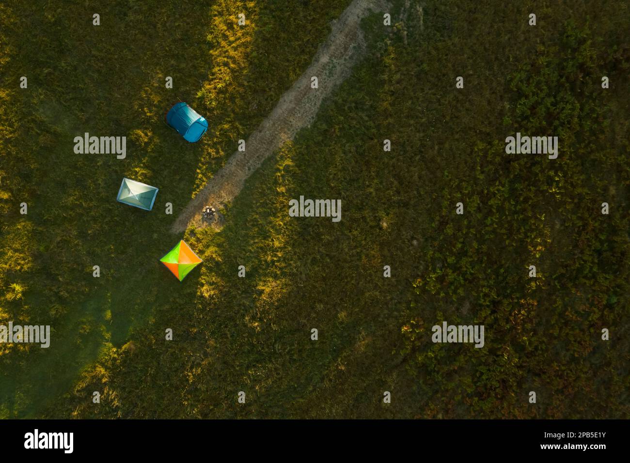 Aerial view of camping tents and bonfire on green meadow Stock Photo ...