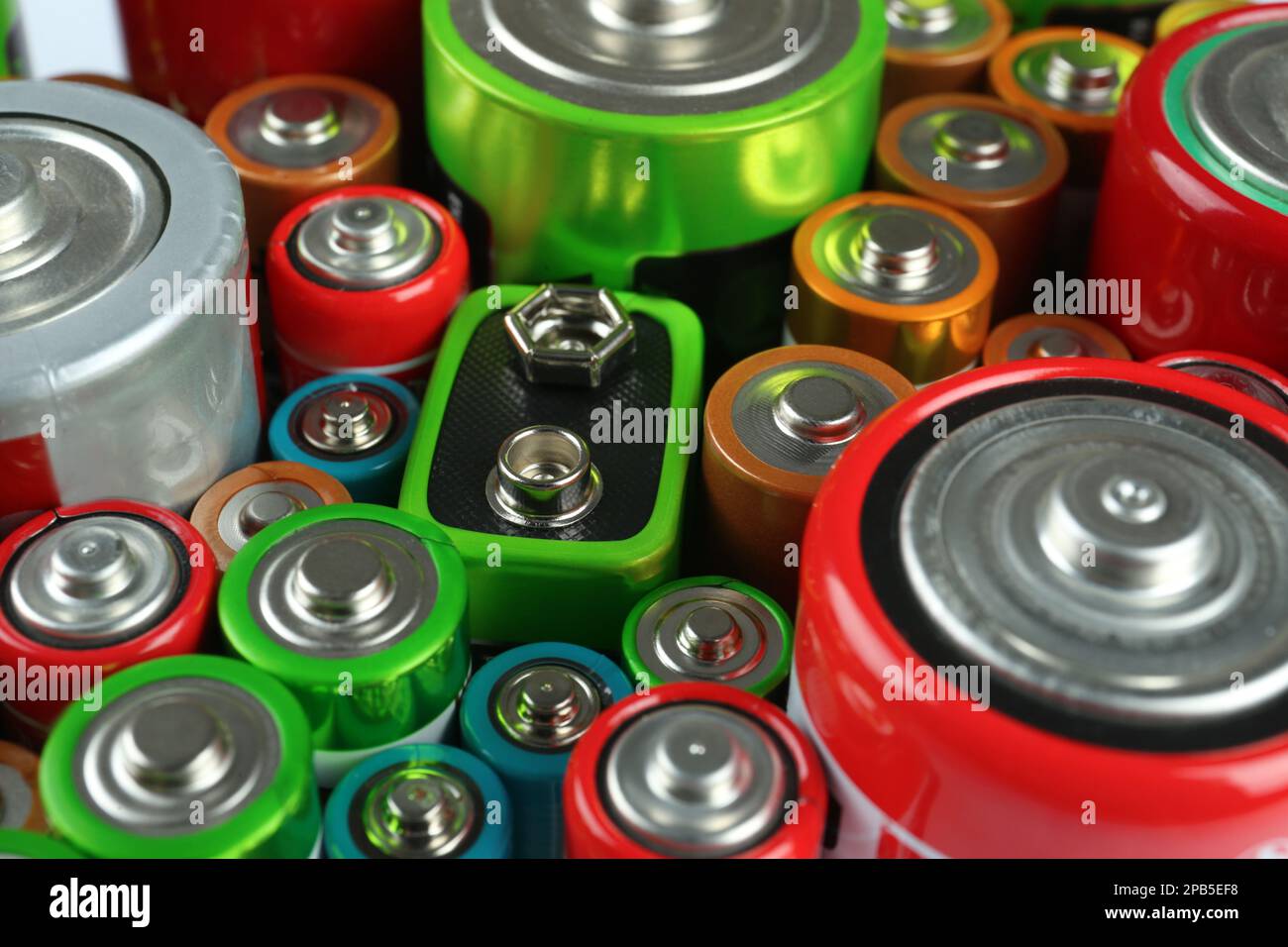 Many batteries of different types as background, closeup view Stock ...