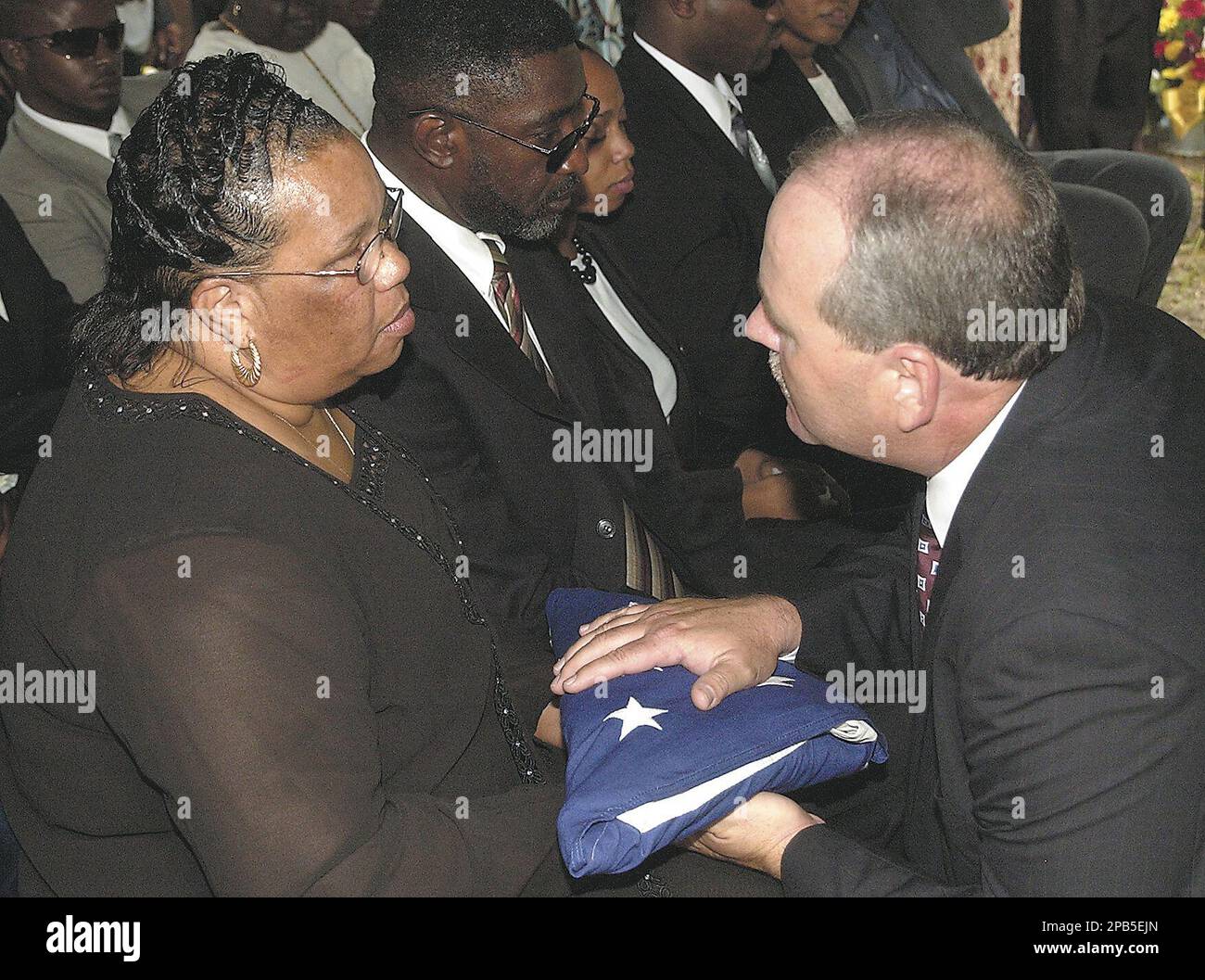 Laura Riley, widow of Jasper County Sheriff Ben Riley, is comforted by ...