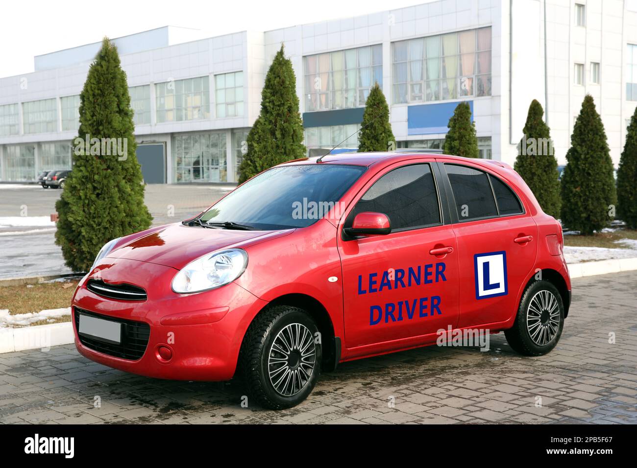 Modern red car L-plate sign on city street Stock Photo - Alamy