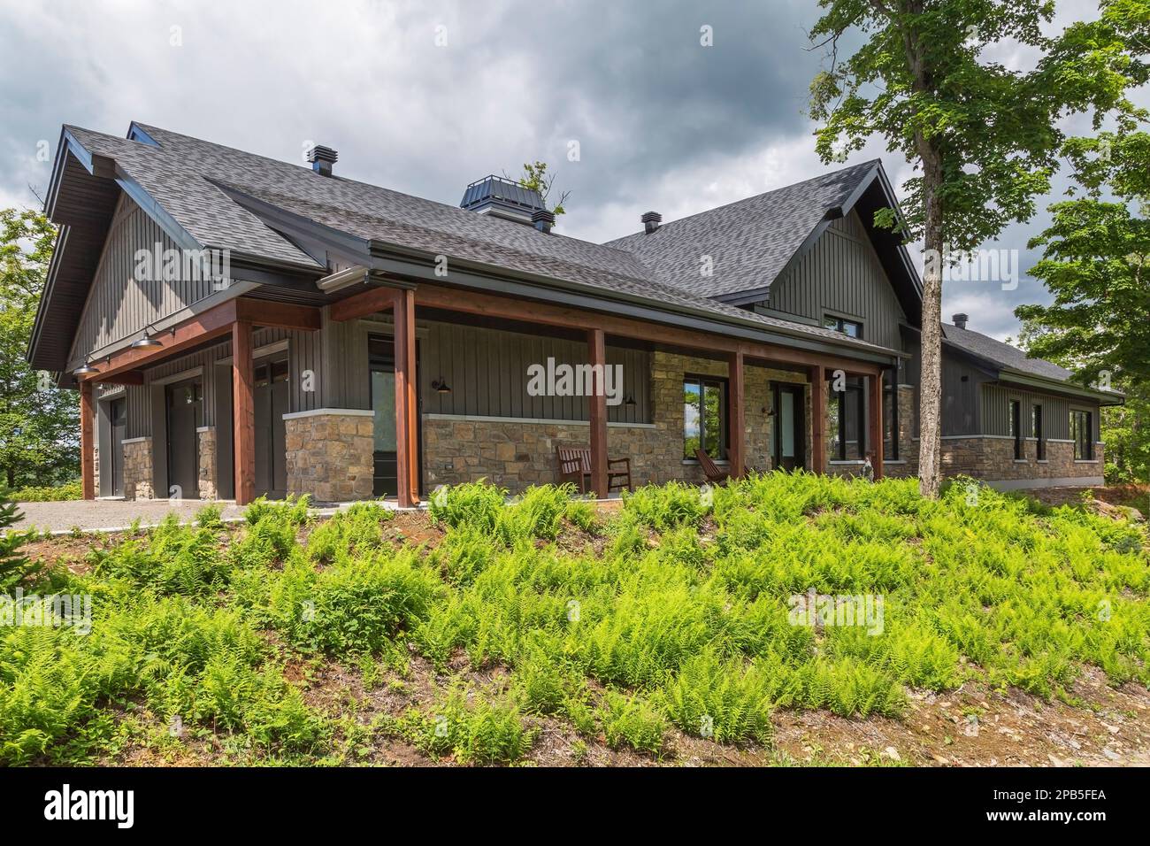 Cut stone and charcoal wood plank with black trim hybrid timber frame ...