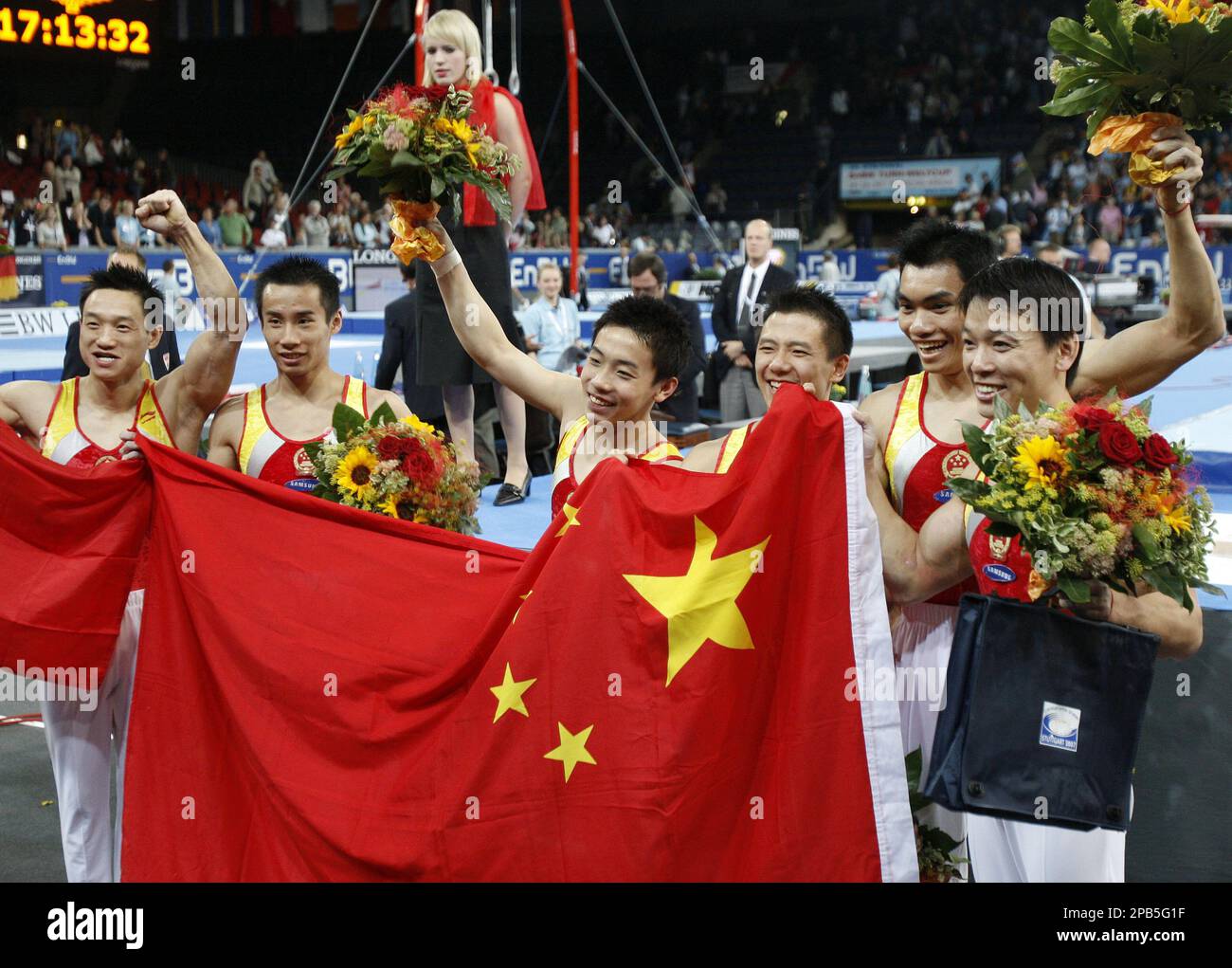 Chinese gymnasts celebrate the gold medal they won in the Men's team ...