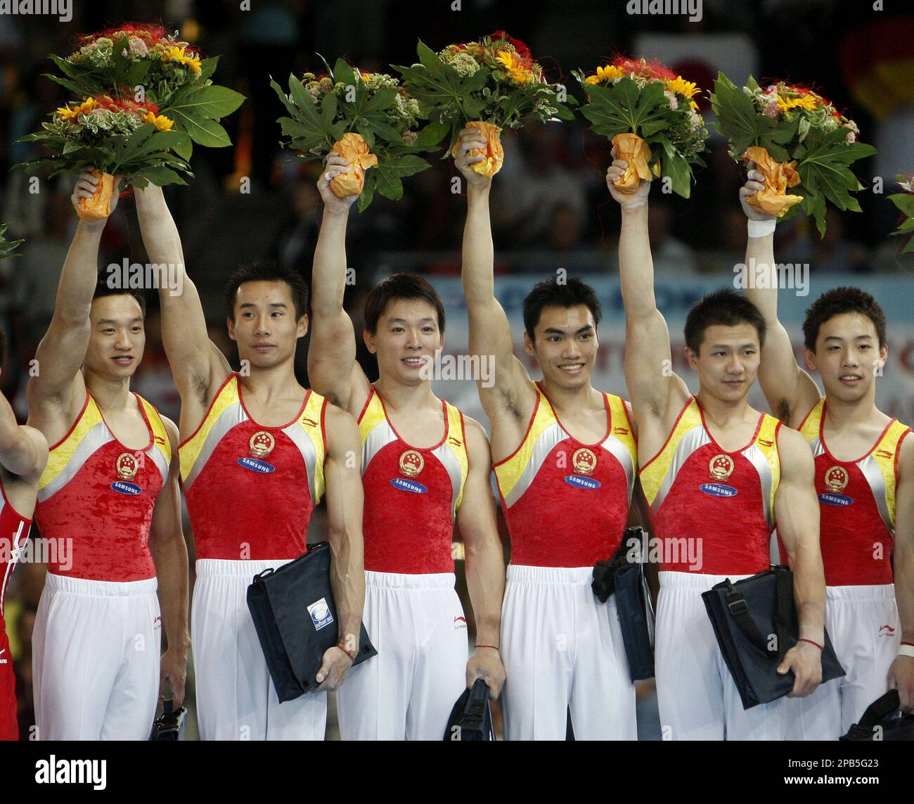 Chinese gymnasts celebrate their gold medal they won in the Men's team ...