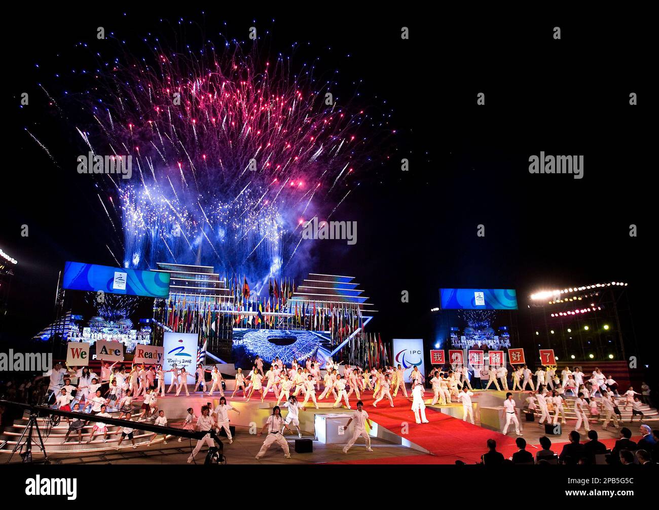 A fireworks display lights up behind the stage while dancers performs ...