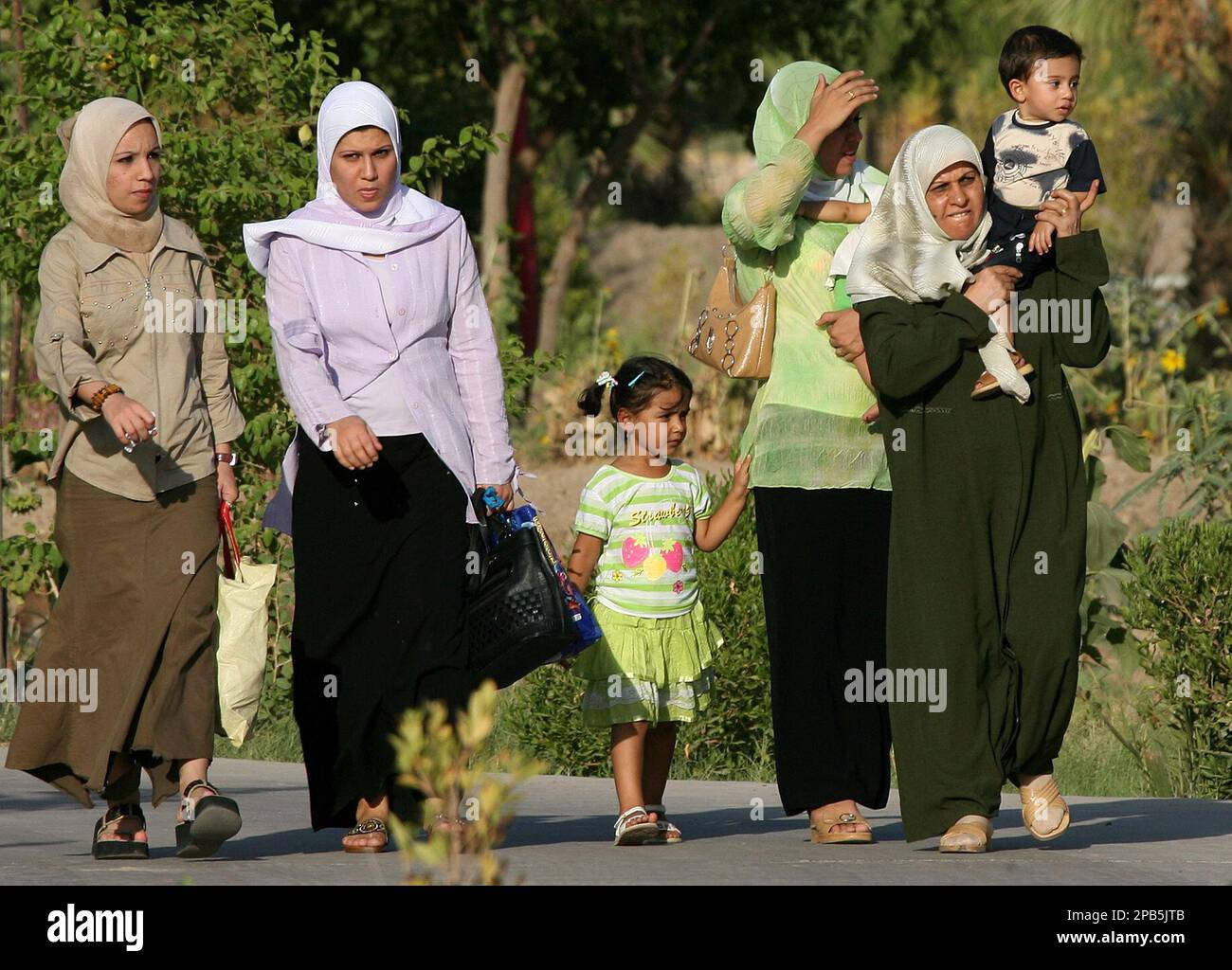 Iraqi women and children walk through Zawraa park in Baghdad, Iraq ...