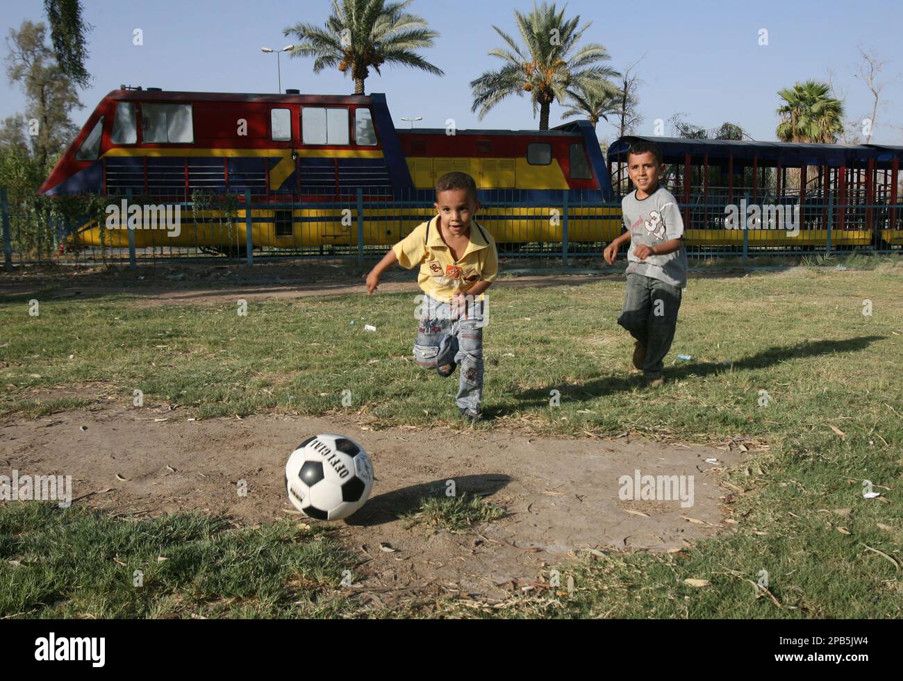 Young Iraqi boys play with a ball in Zawraa park in Baghdad, Iraq ...