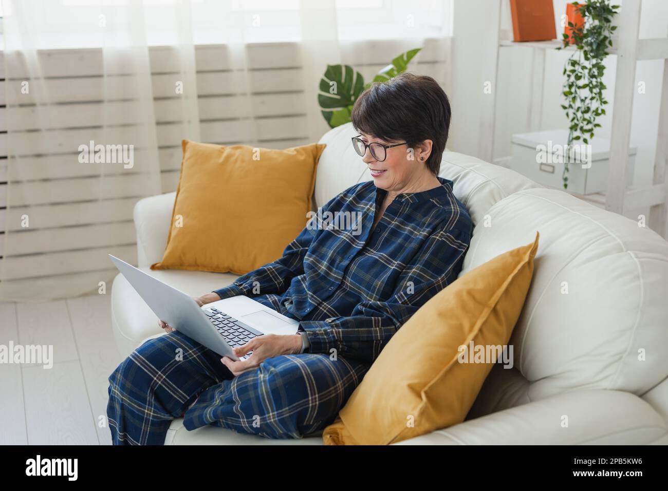 Work online remote from home concept. Woman relaxing in pajama while ...