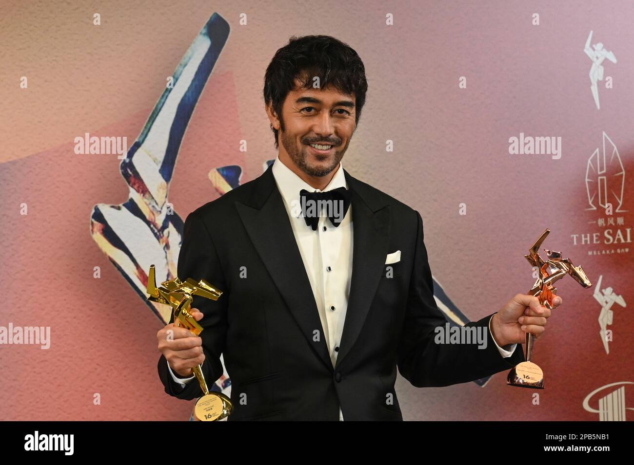 Japanese actor Abe Hiroshi, poses for photographs after winning the ...