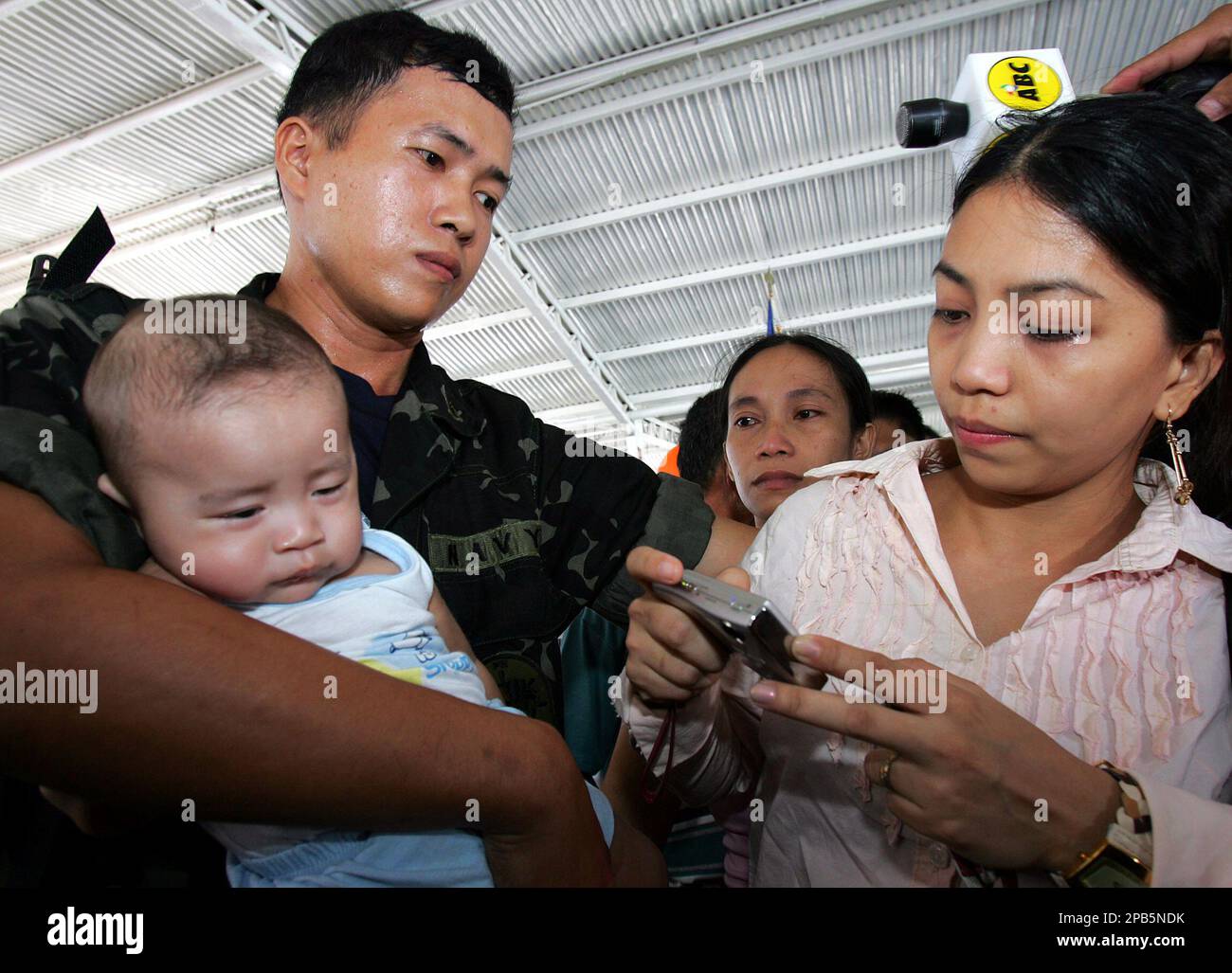 Ensign Jeffrey Legaspi of the Philippine Navy's 1st Mobile Construction Battallion carries his 4 ...
