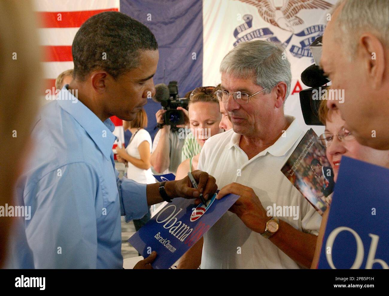 Democratic presidential hopeful Barack Obama signs an autograph for ...