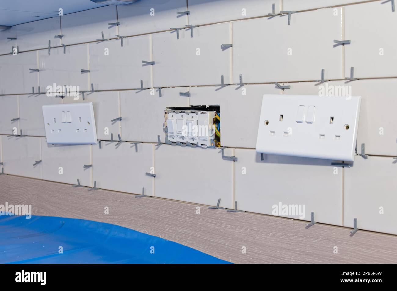 New tile installation in kitchen with electrical sockets removed Stock ...