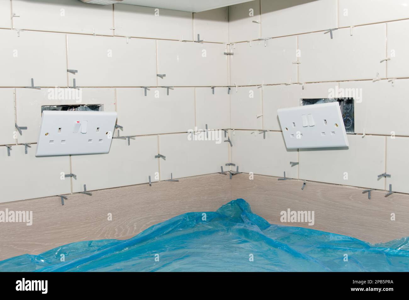 New tile installation in kitchen with electrical sockets removed Stock ...