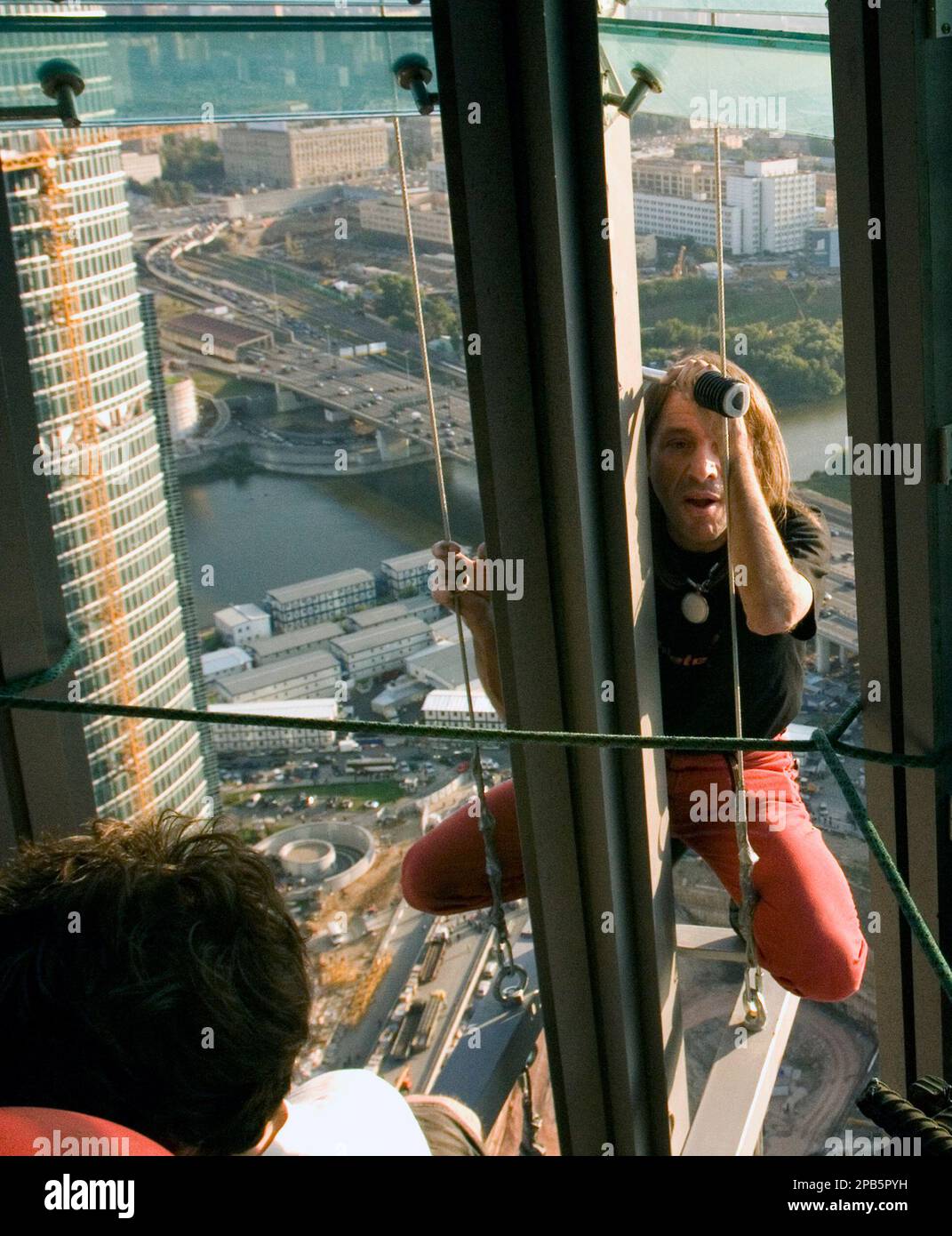 French climber Alain Robert, known as 'Spiderman,' climbs a 242-meter ...