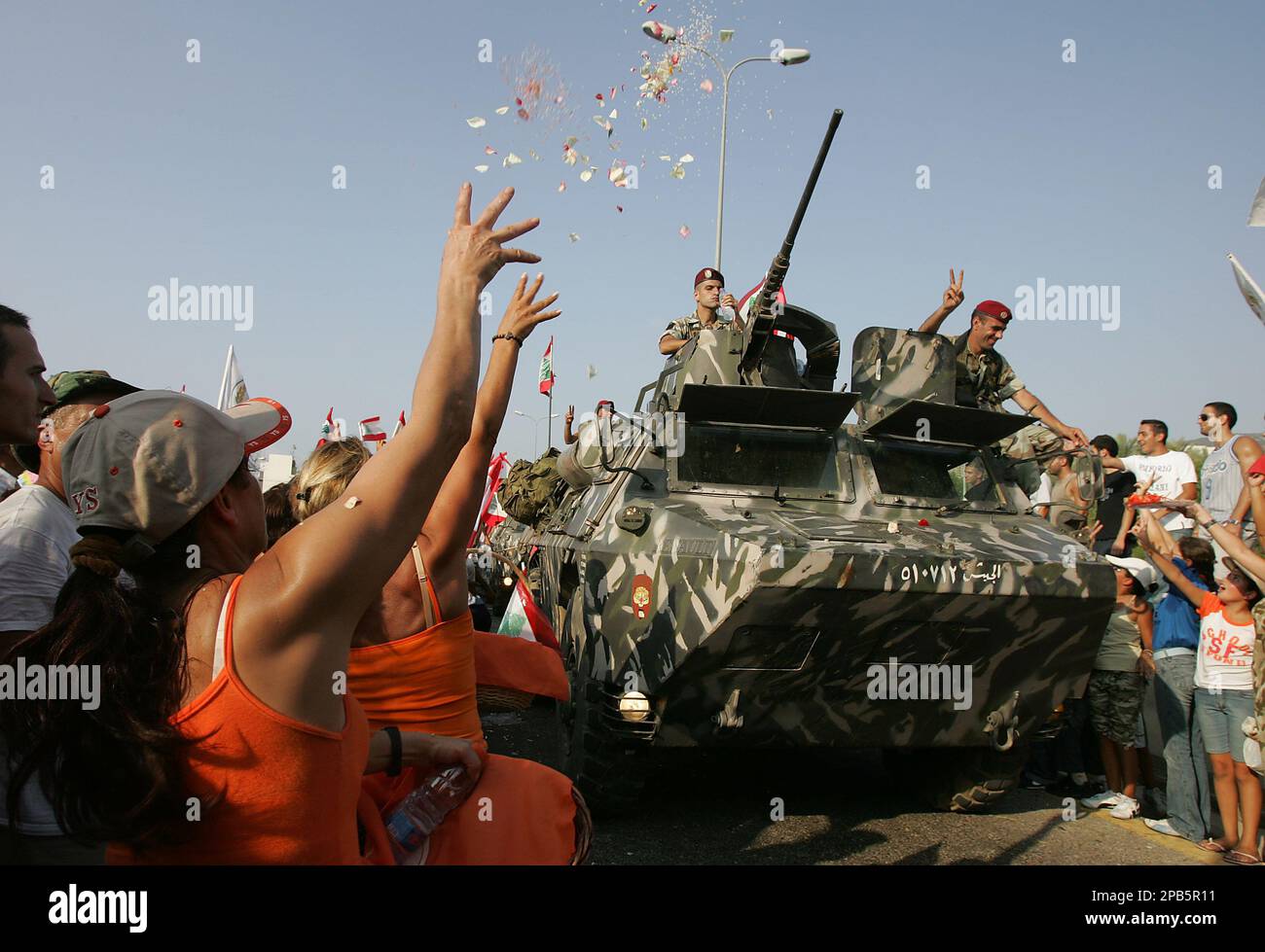 A Lebanese woman, throws flowers to Lebanese special forces soldiers ...
