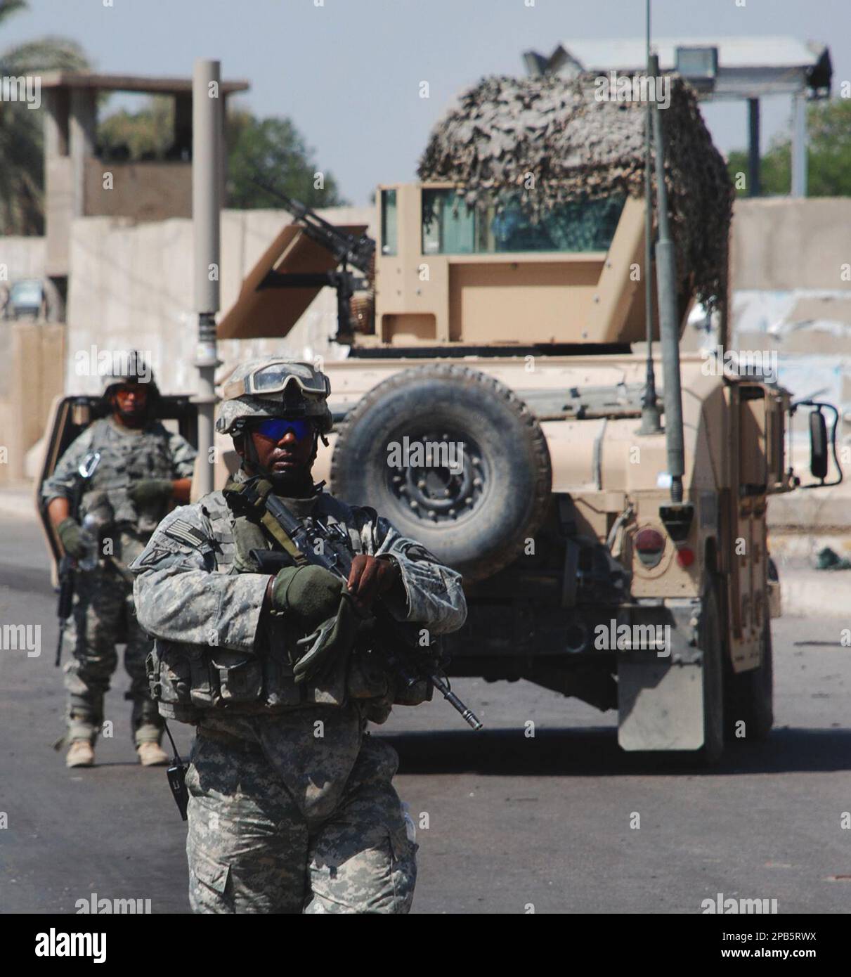 U.S. Army troops guard a checkpoint in the Mansour district in western ...