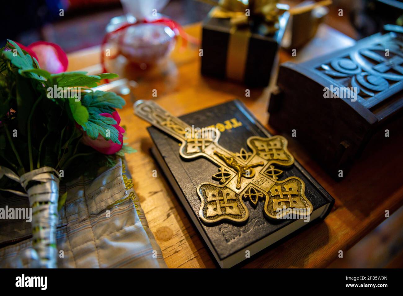 A golden cross on the table on top of a bible in a church, preparing ...