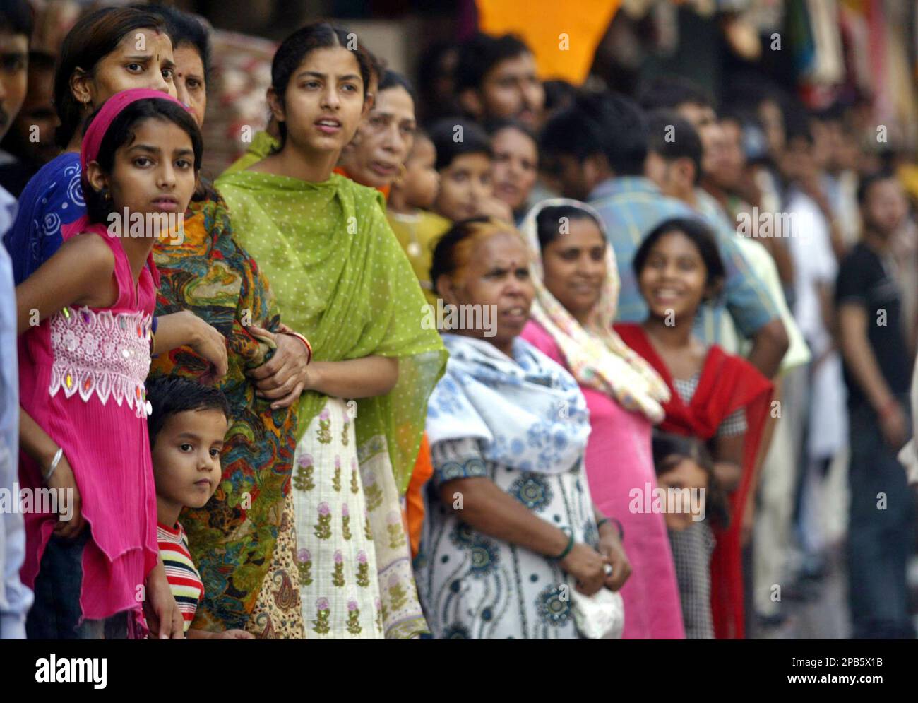People watch a 'Janmashtami' procession in Jammu, India, Monday, Sept.3 ...