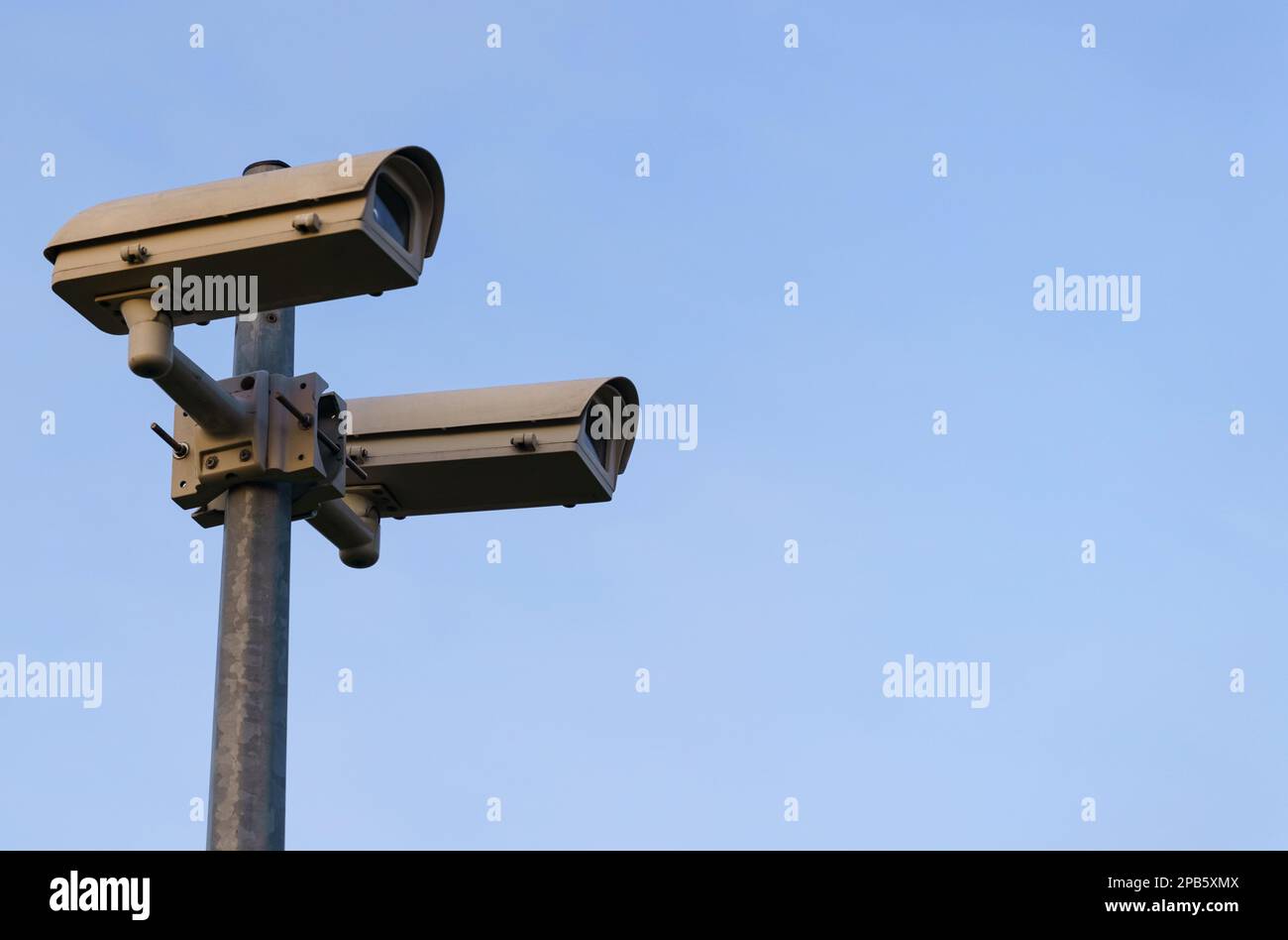 Surveillance cameras mounted on a pole against the blue sky. Video ...