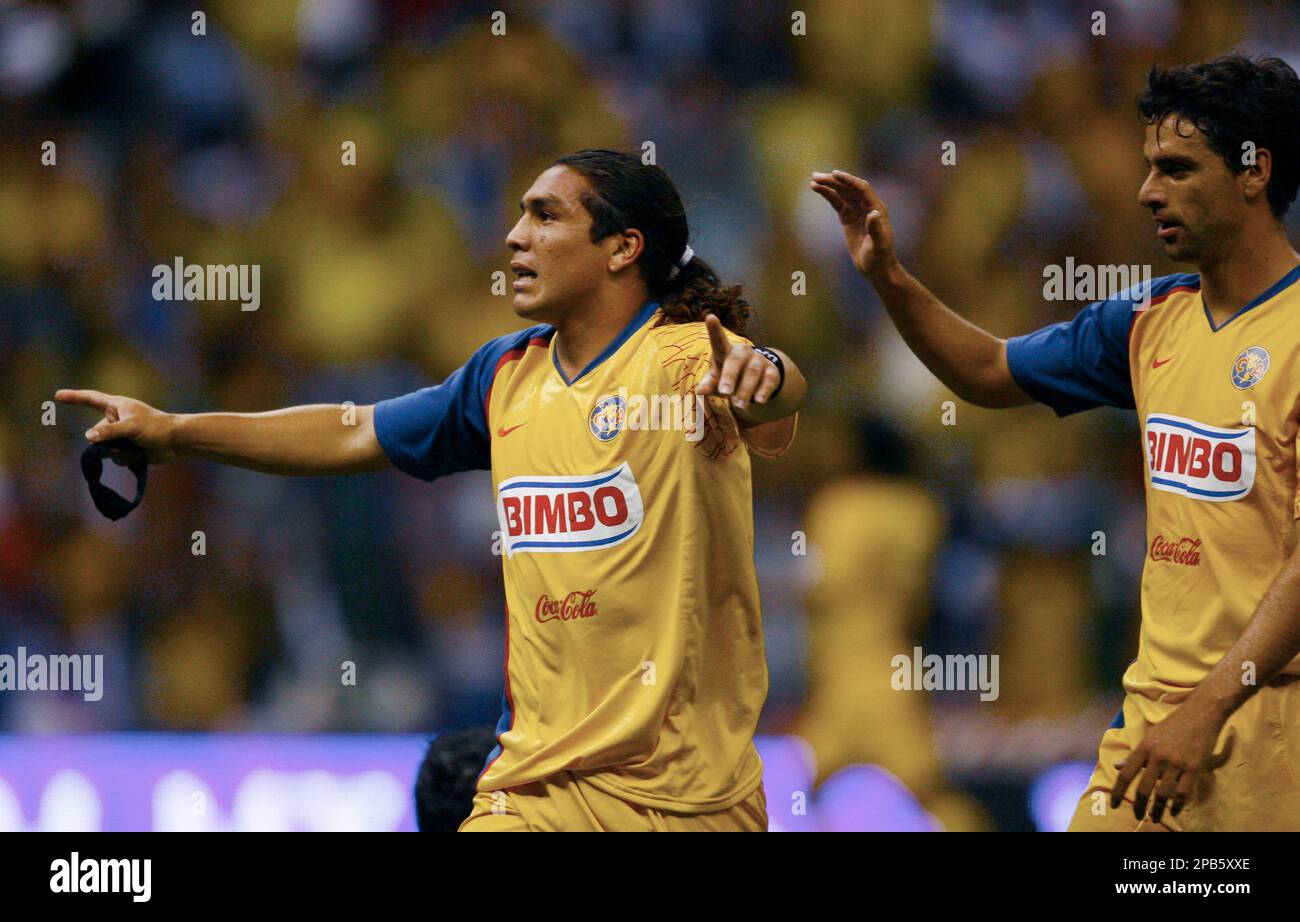 America's Salvador Cabanas, from Paraguay, left, celebrates his goal as ...