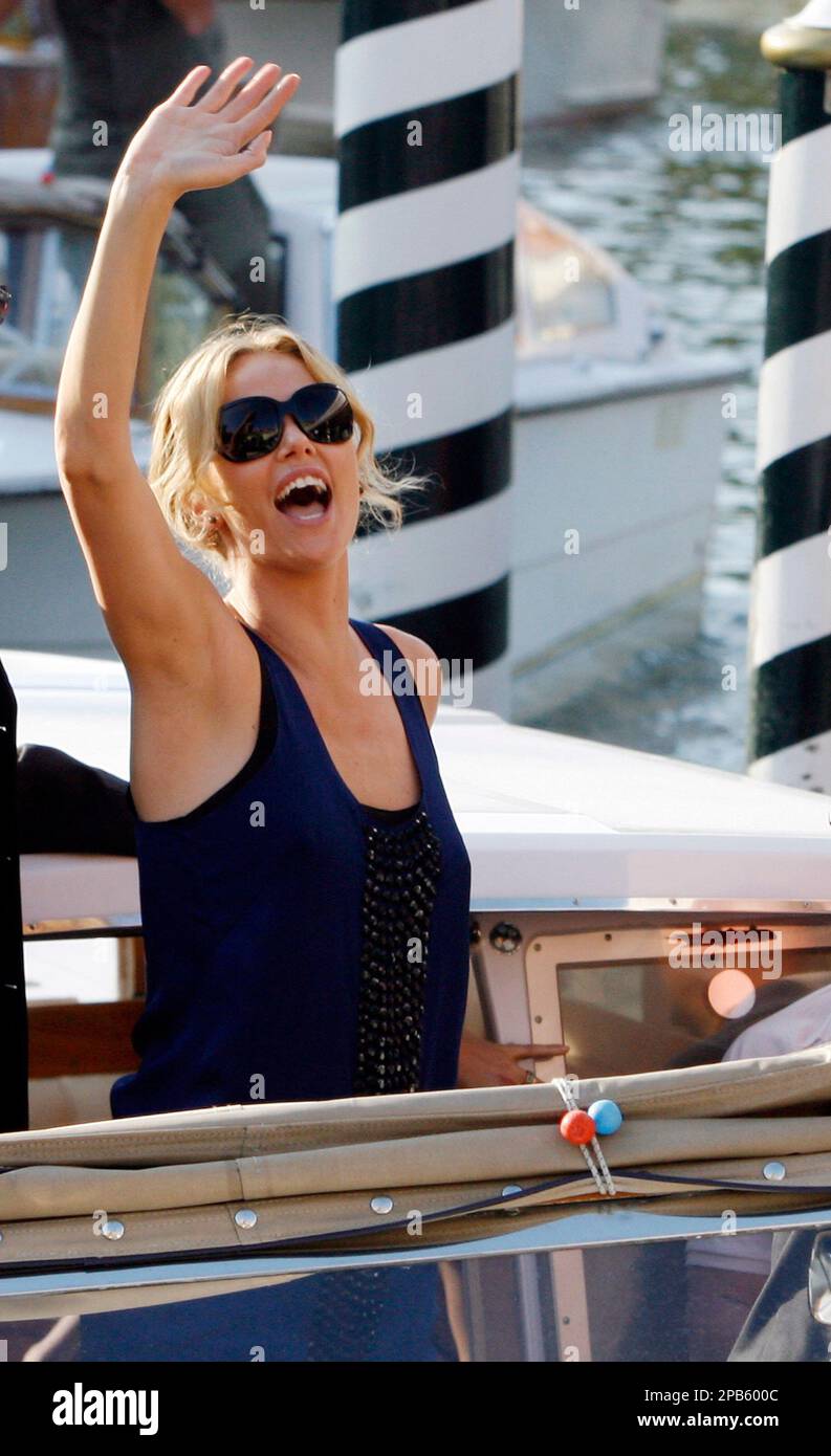 Actress Charlize Theron waves from a boat in Venice's Lido, Italy ...