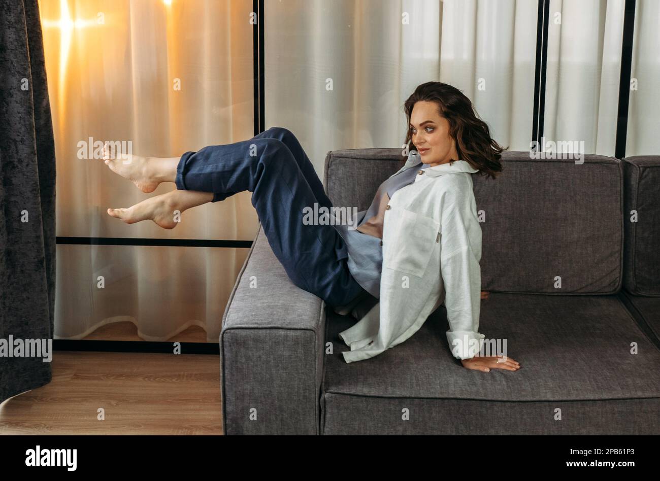 Woman lying on back legs up hi-res stock photography and images - Alamy