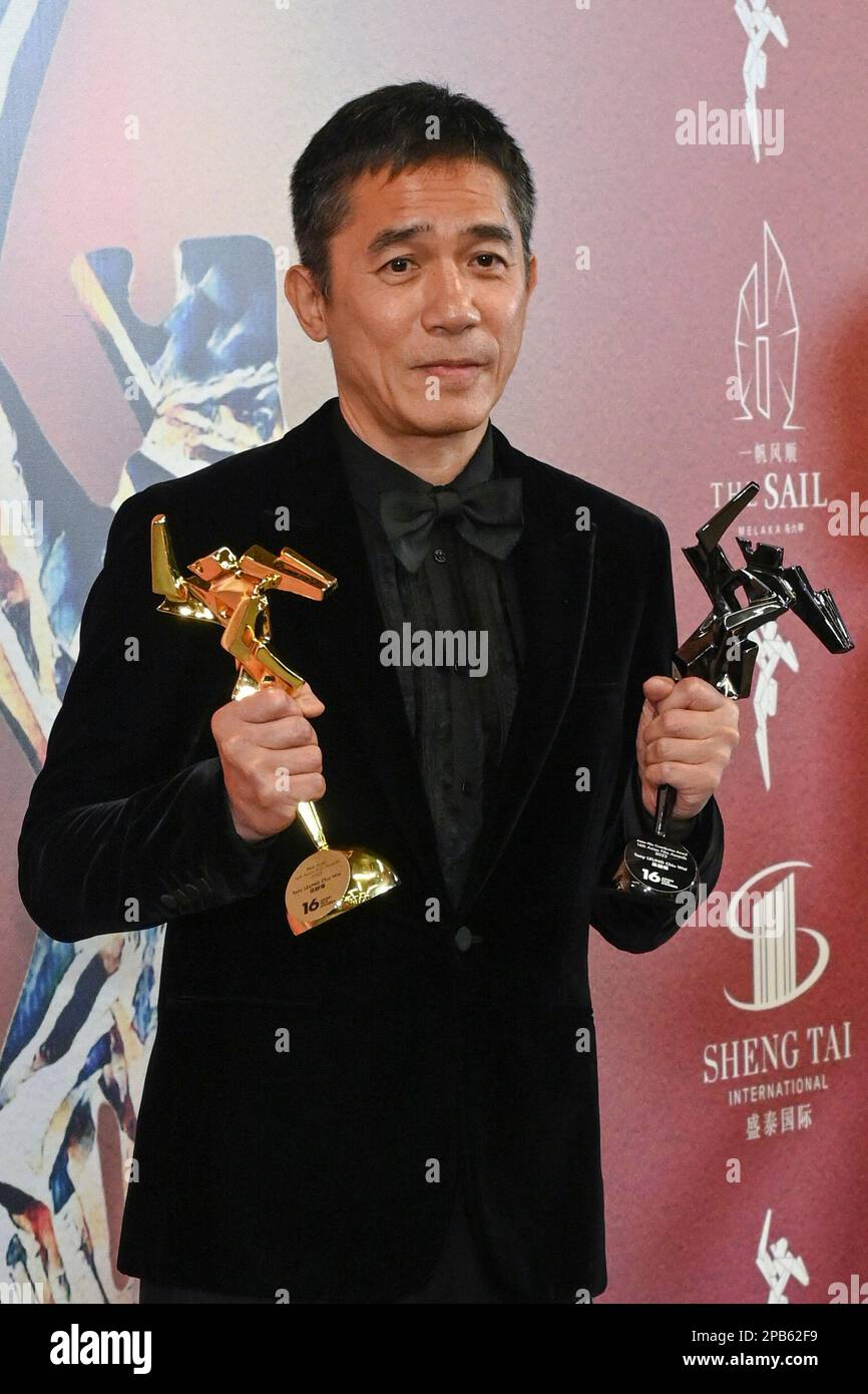 Tony Leung Chiu Wai poses with his award after winning the Best actor with 'Where the Wind Blows ...