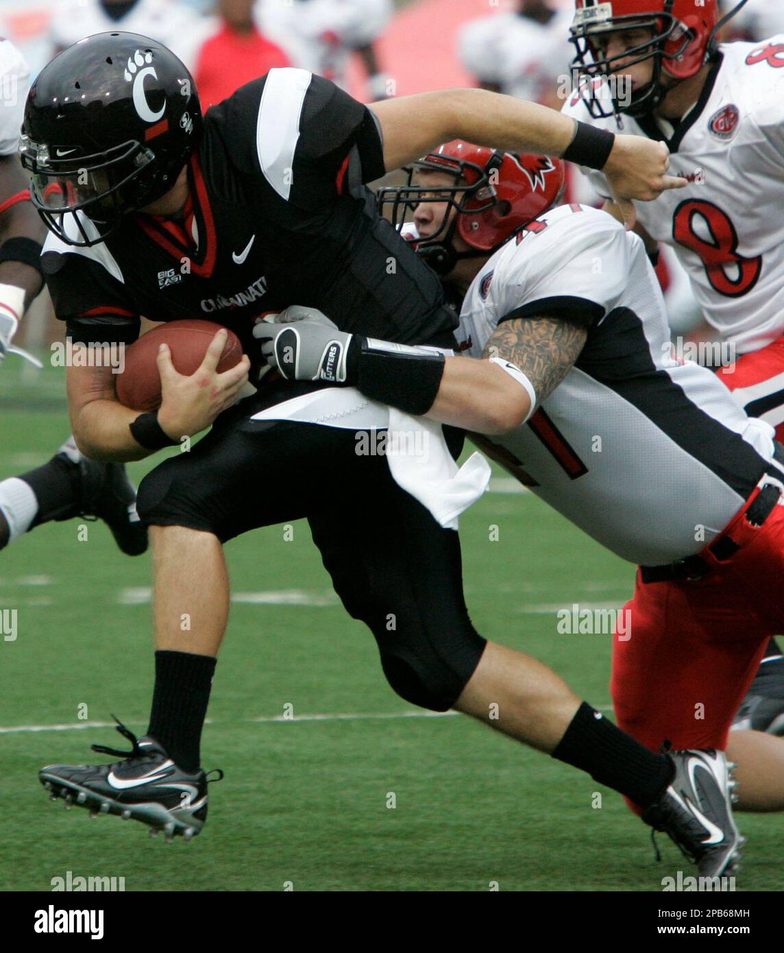 Cincinnati quarterback Ben Mauk is tackled by Southeast Missouri State ...