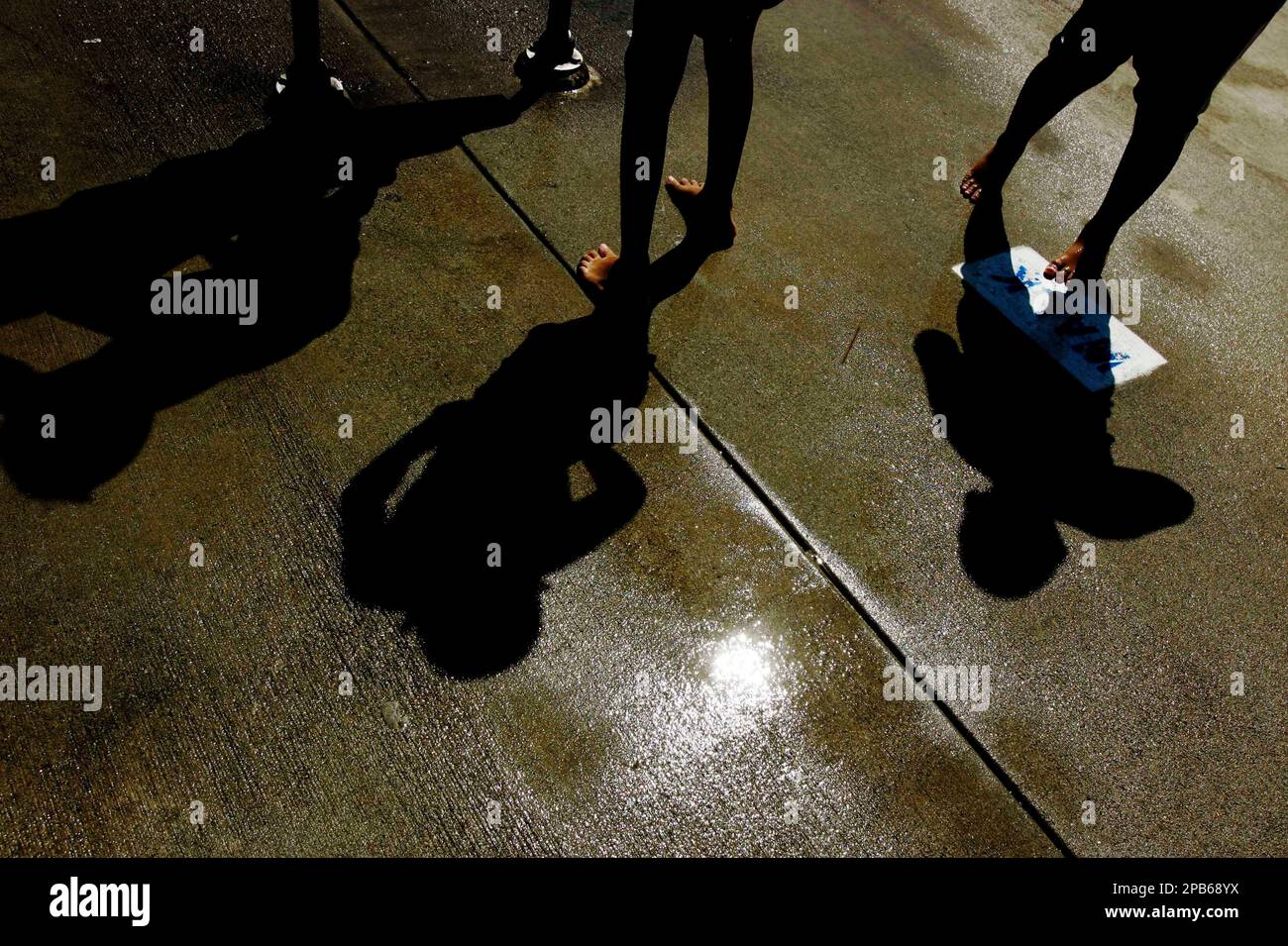 A the afternoon hot sun cast long shadows on the concrete floor of ...