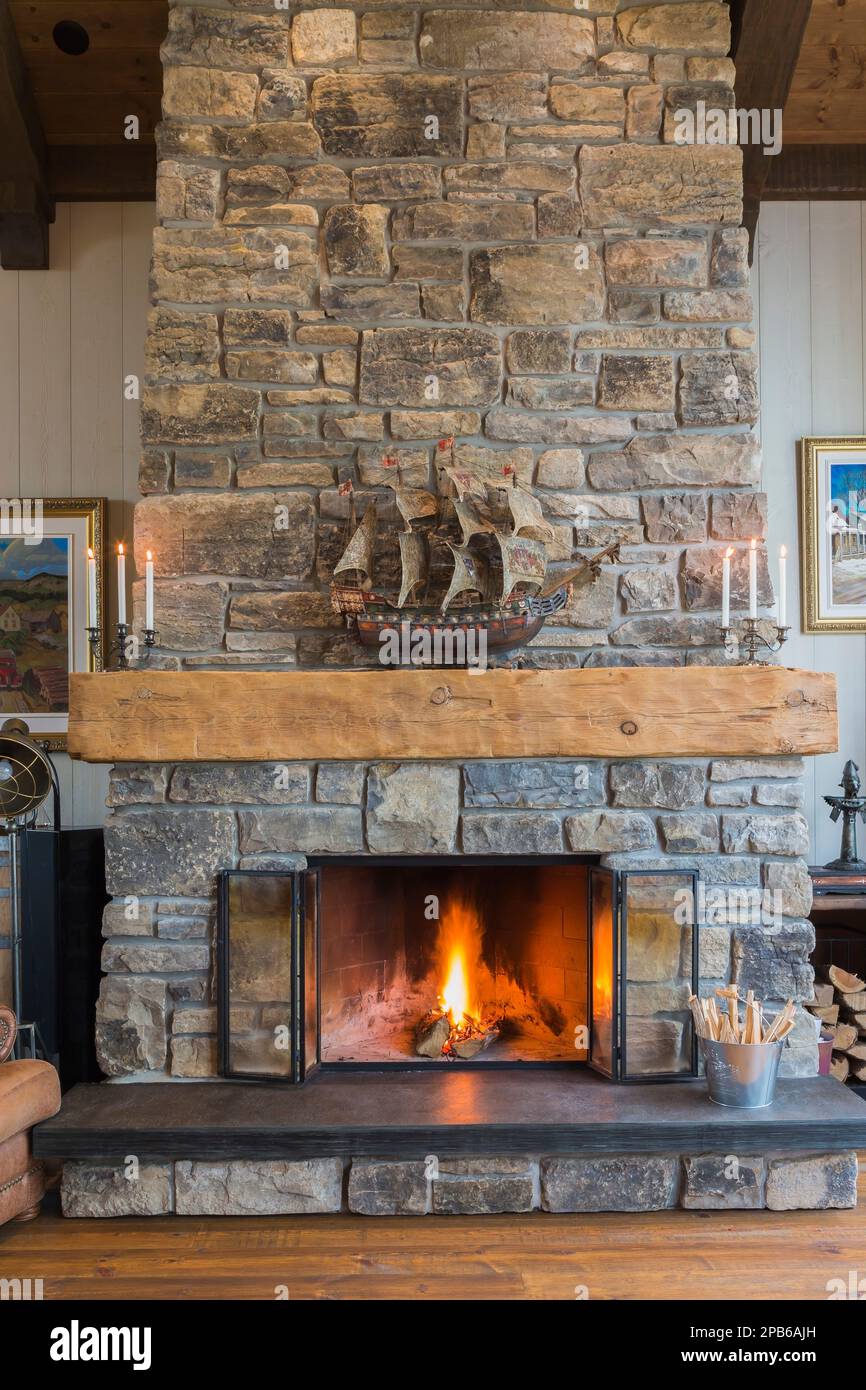 Natural cut stone wood burning fireplace in living room inside hybrid ...