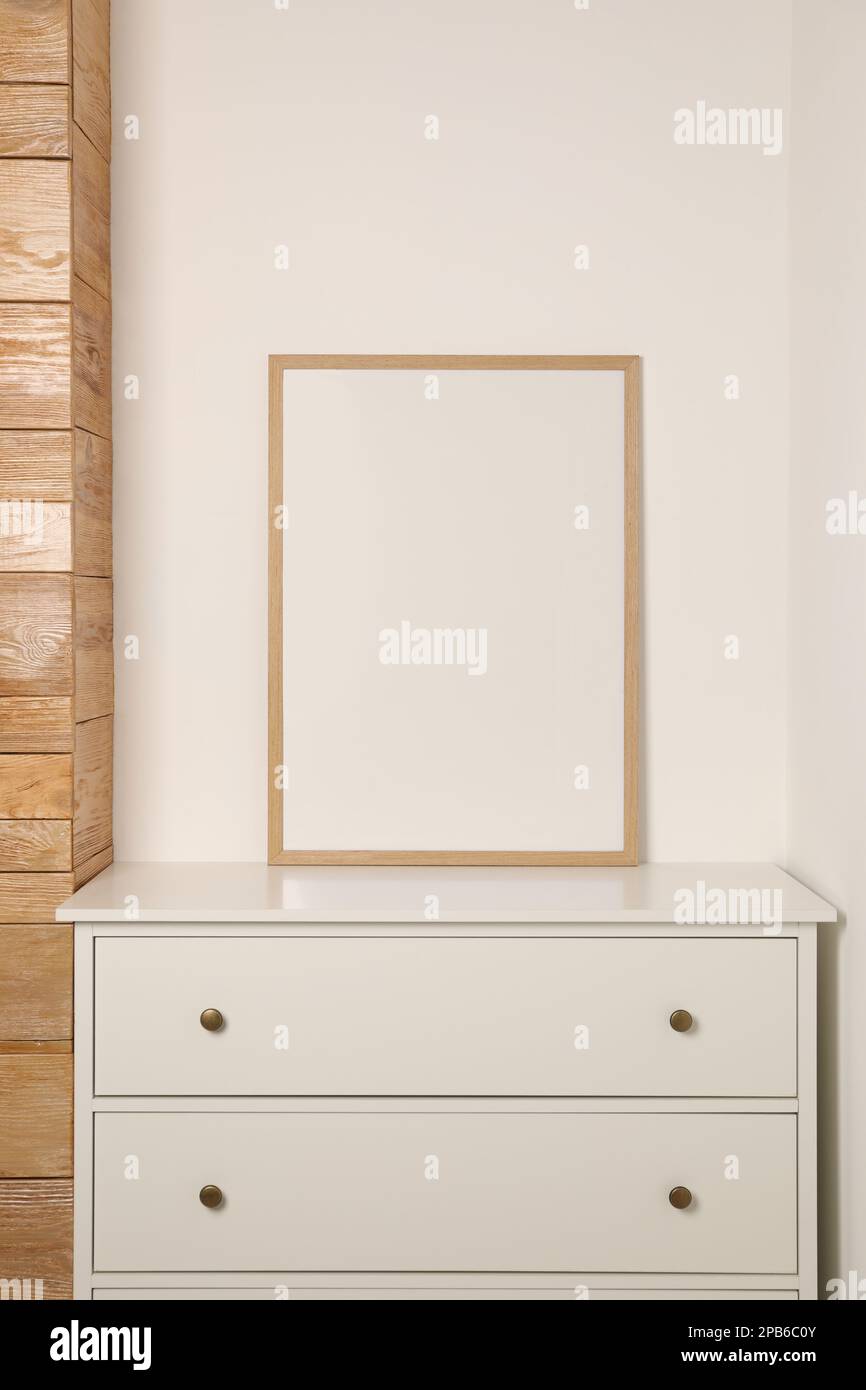 Blank frame on chest of drawers indoors. Space for design Stock Photo ...
