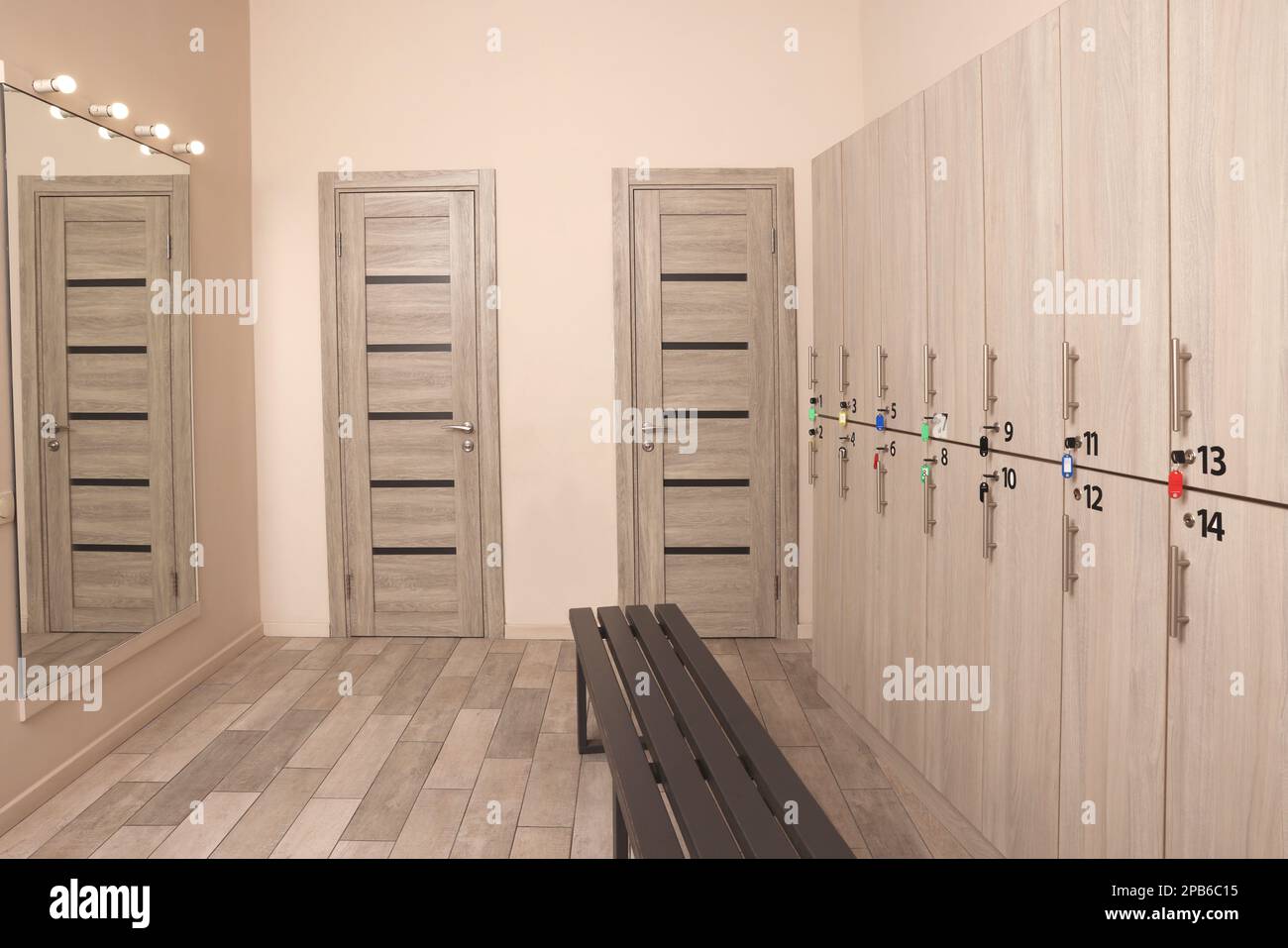 Wooden bench, mirror and lockers in changing room interior Stock Photo ...