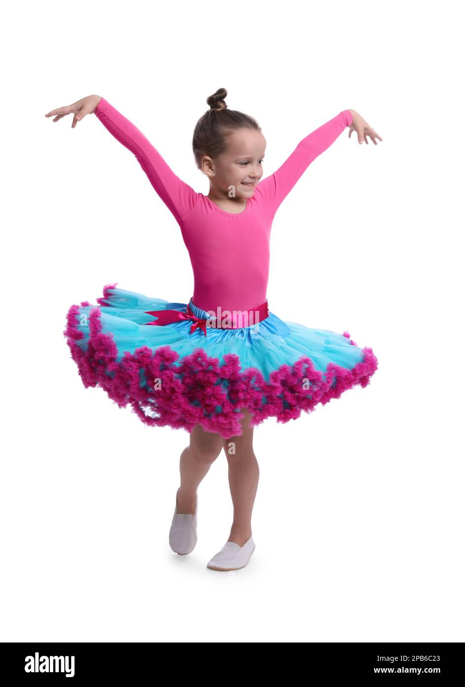 Cute little girl in costume dancing on white background Stock Photo - Alamy