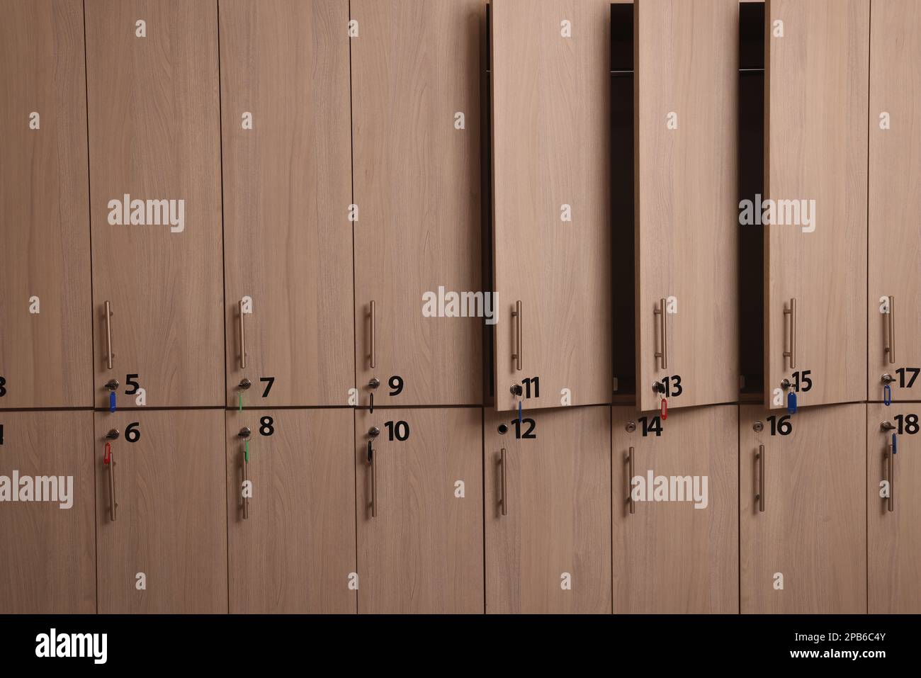 Many wooden lockers with keys and numbers on doors Stock Photo - Alamy