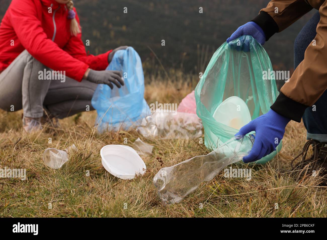People with trash bags collecting garbage in nature, closeup Stock ...