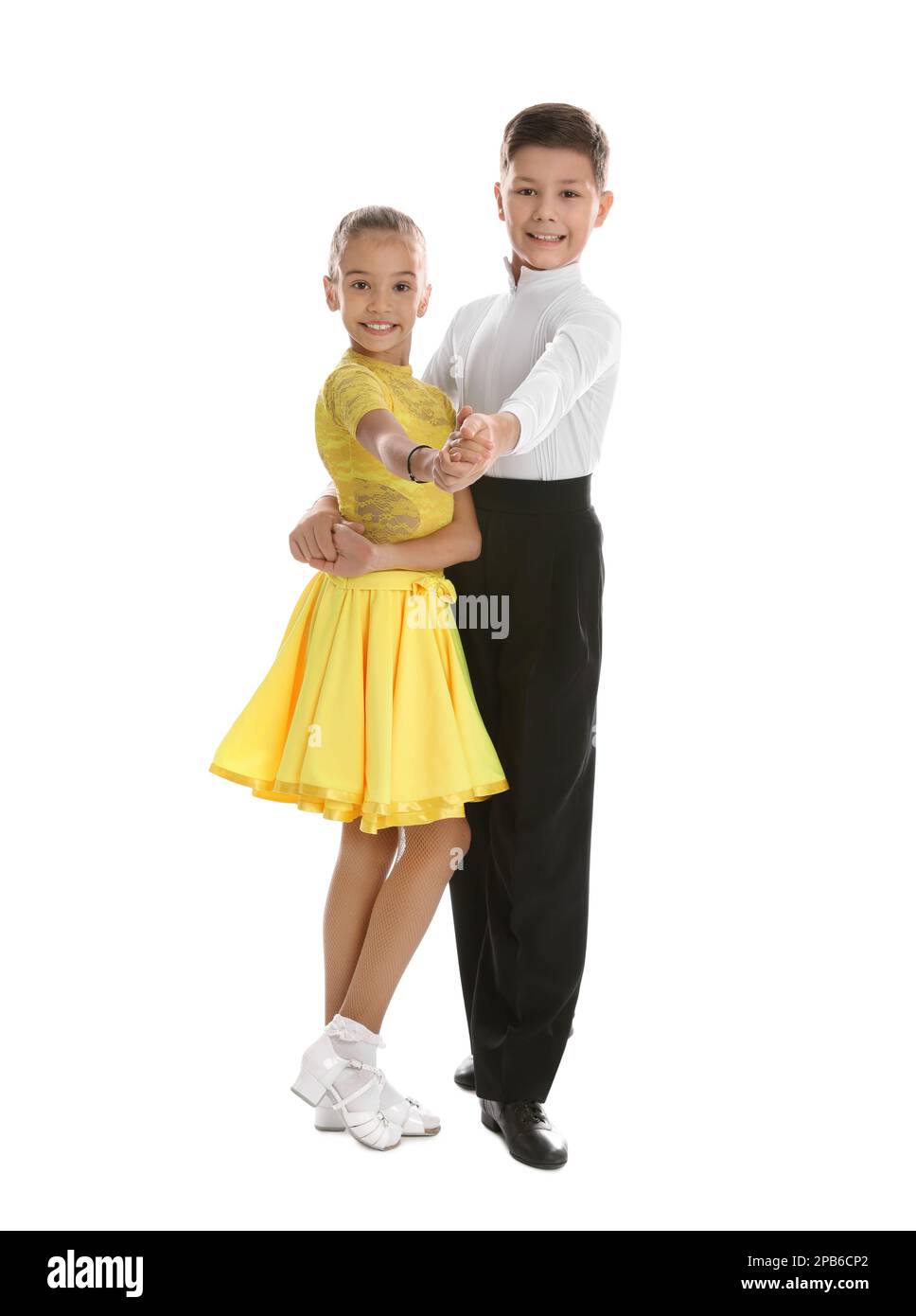Beautifully dressed couple of kids dancing on white background Stock ...