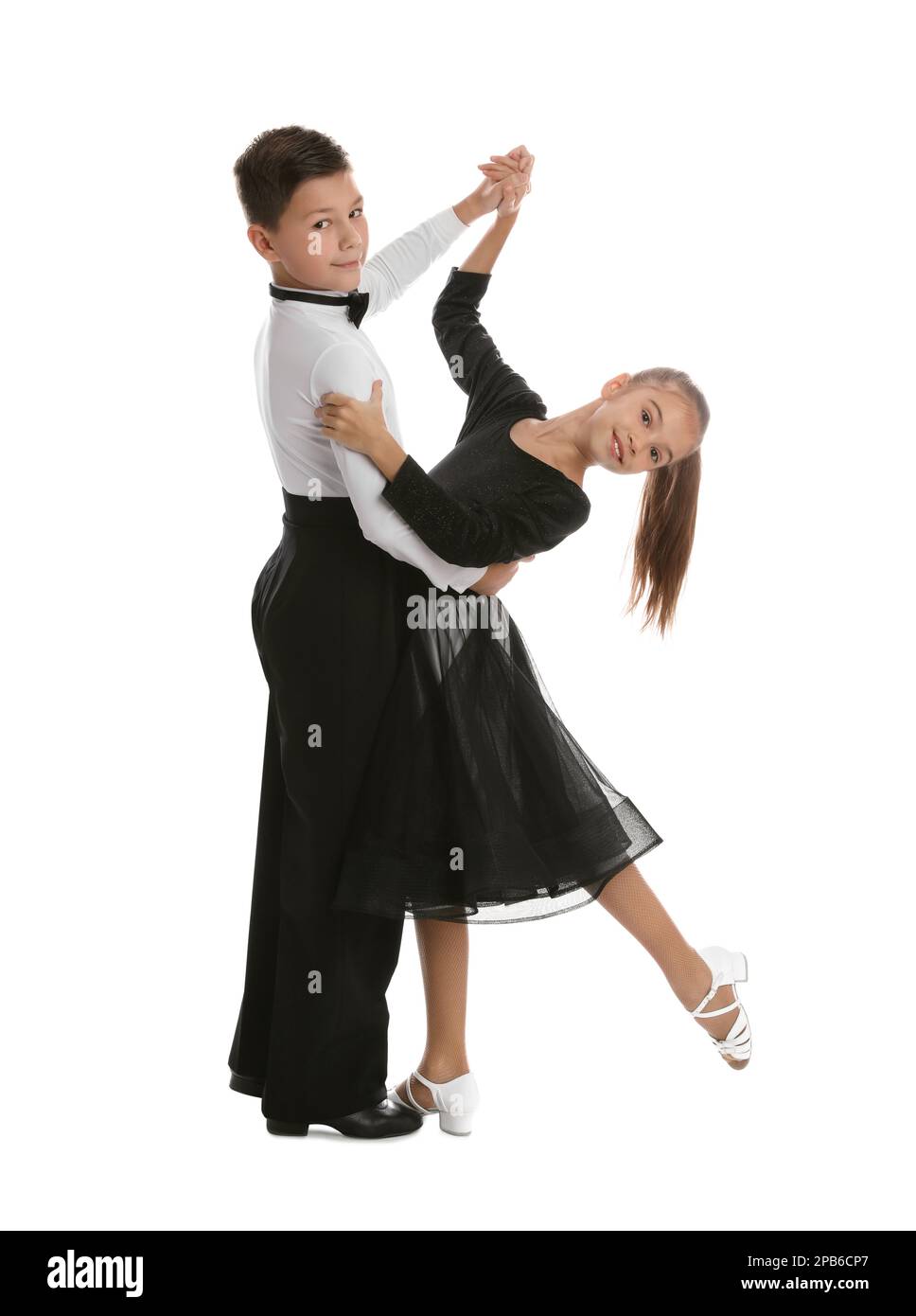 Beautifully dressed couple of kids dancing on white background Stock ...