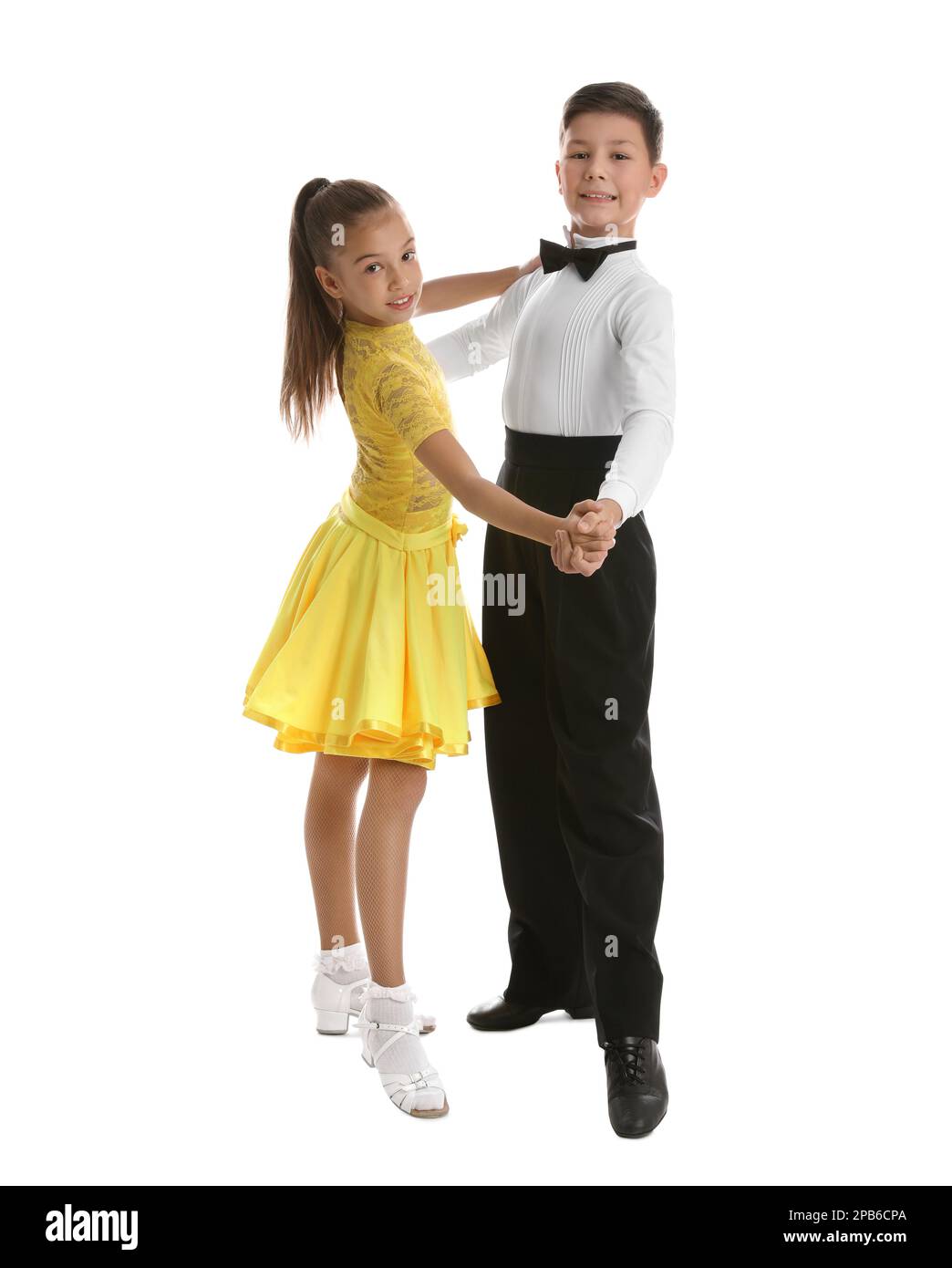 Beautifully dressed couple of kids dancing on white background Stock ...