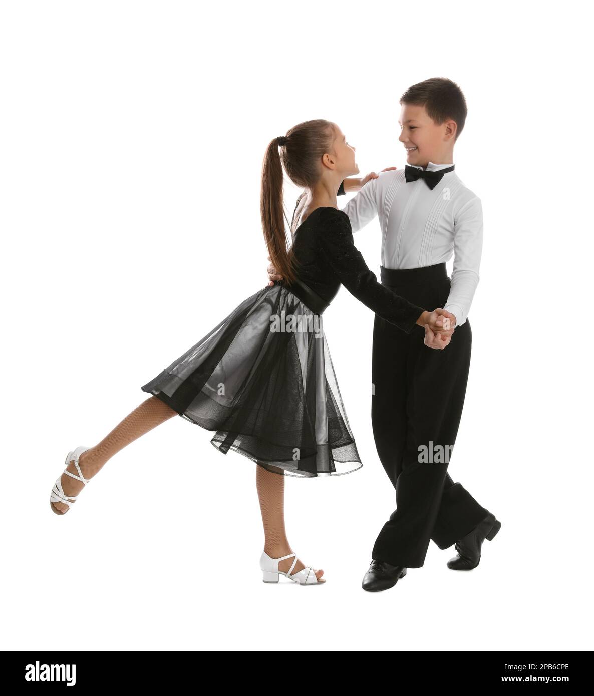 Beautifully dressed couple of kids dancing on white background Stock ...