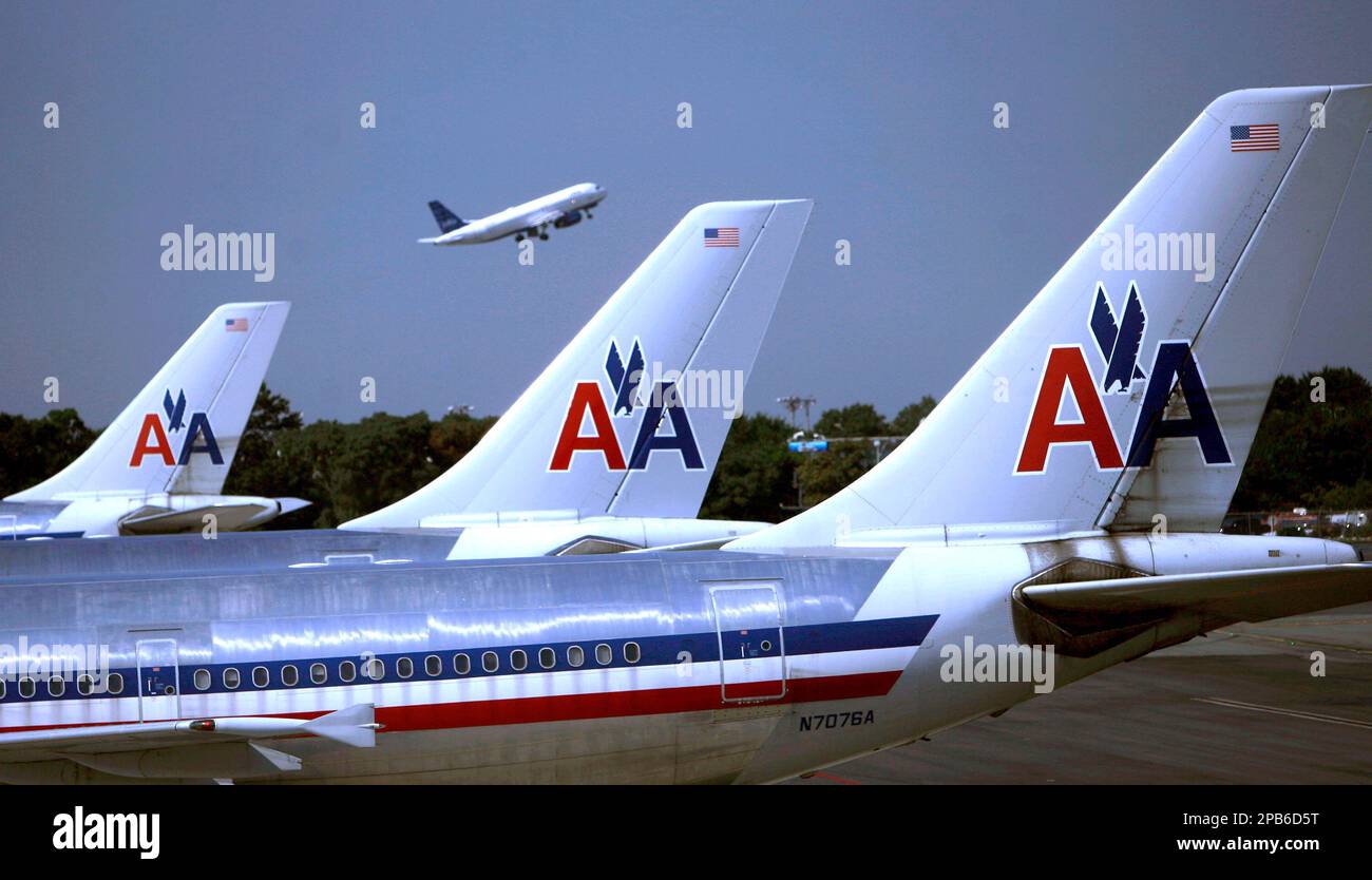 American Airlines planes sit at their gates at John F. Kennedy ...