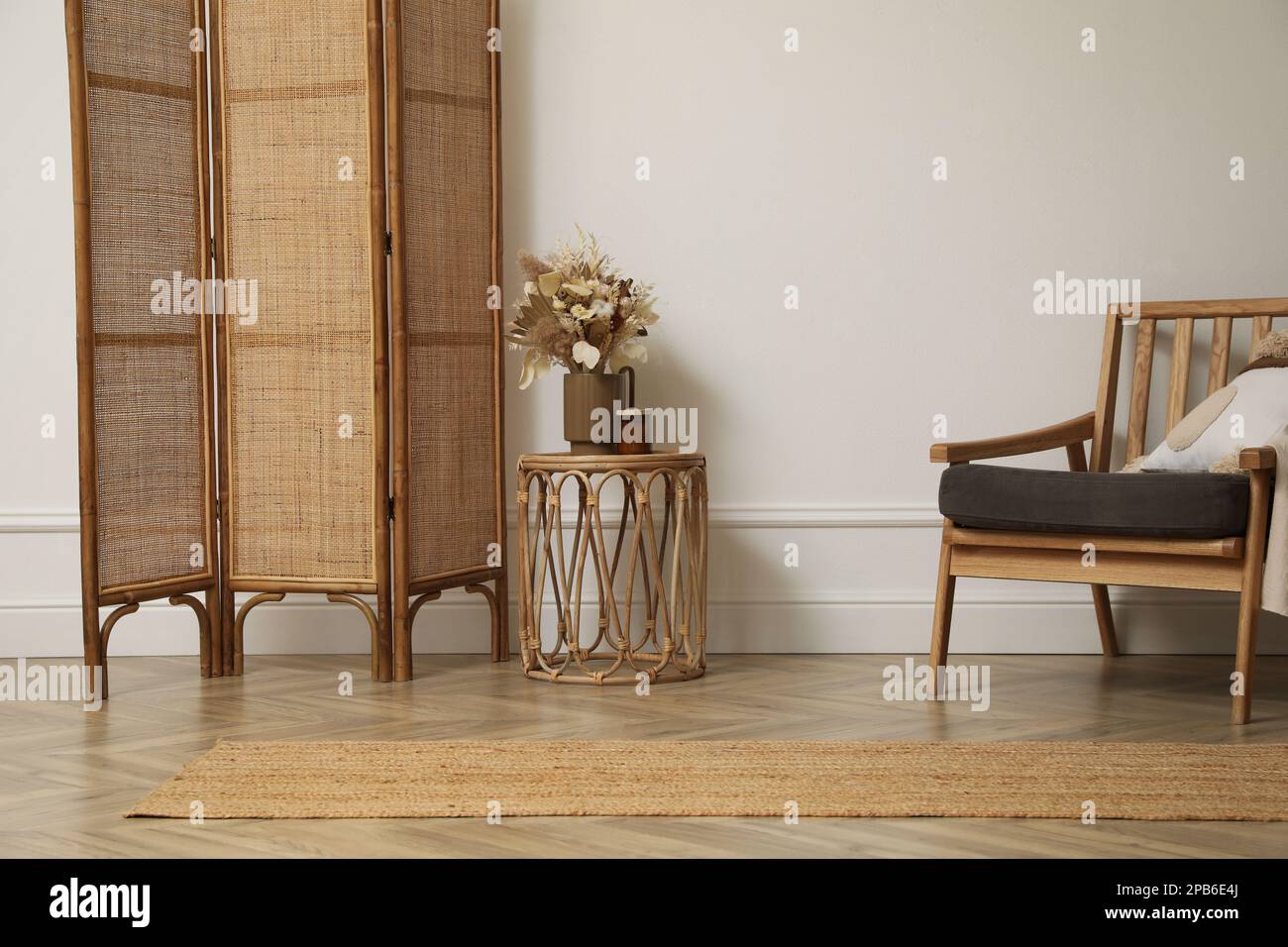Stylish room with folding screen and armchair. Interior design Stock ...