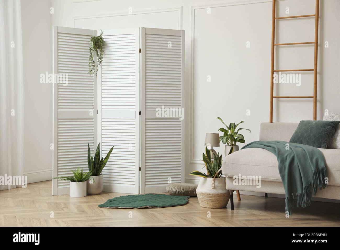Stylish living room with folding screen and sofa. Interior design Stock ...