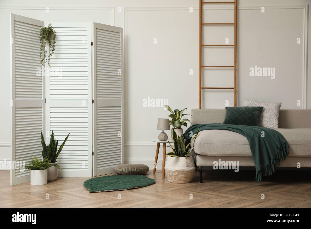 Stylish living room with folding screen and sofa. Interior design Stock ...