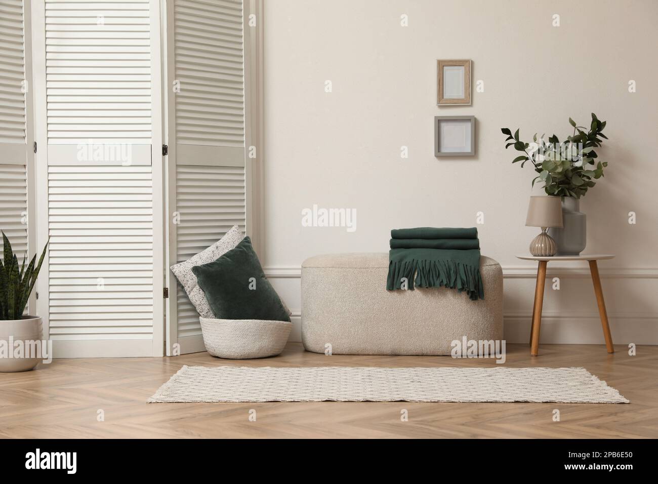 Stylish room with folding screen and furniture. Interior design Stock ...